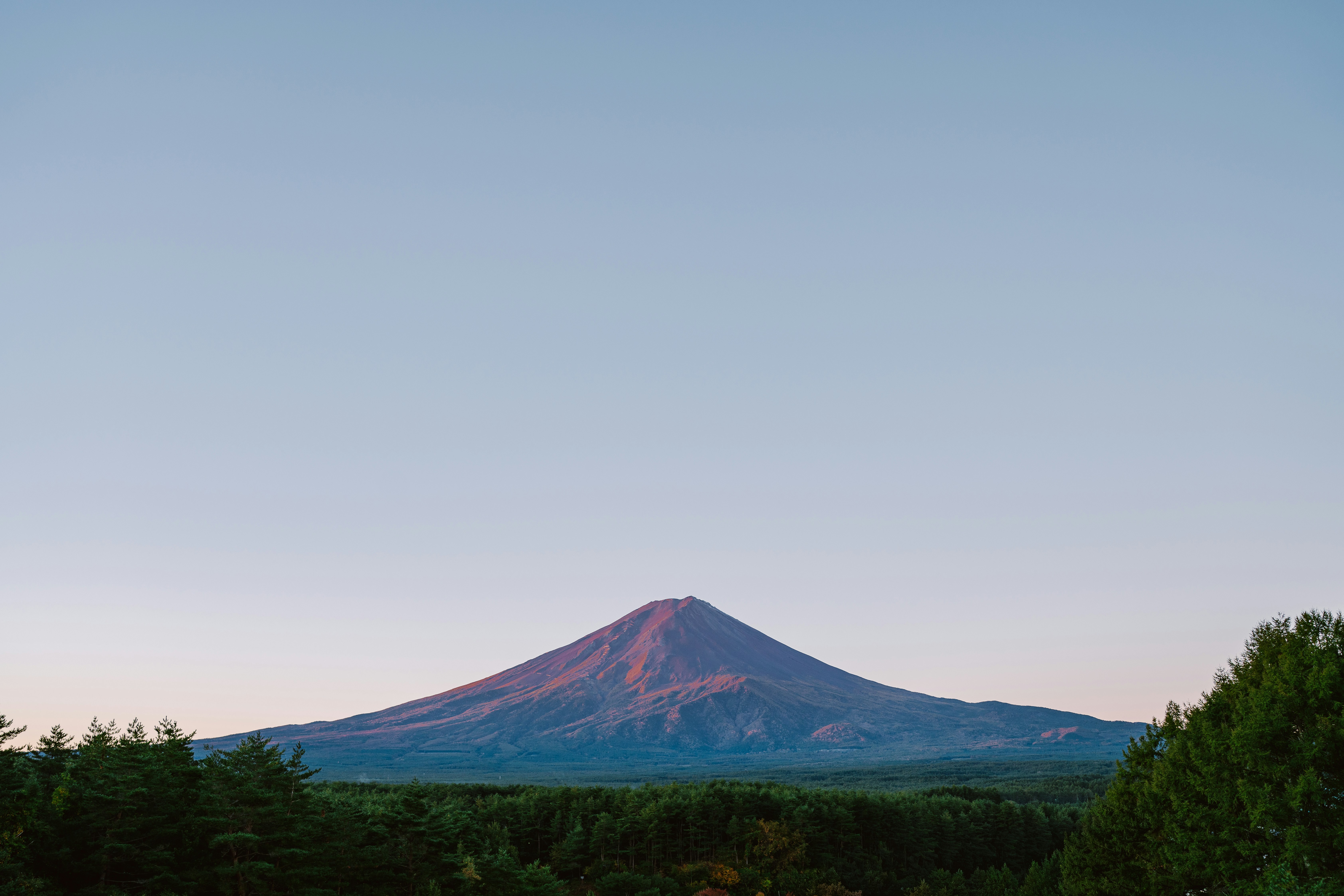 Majestic mountain peak at sunrise with clear sky.