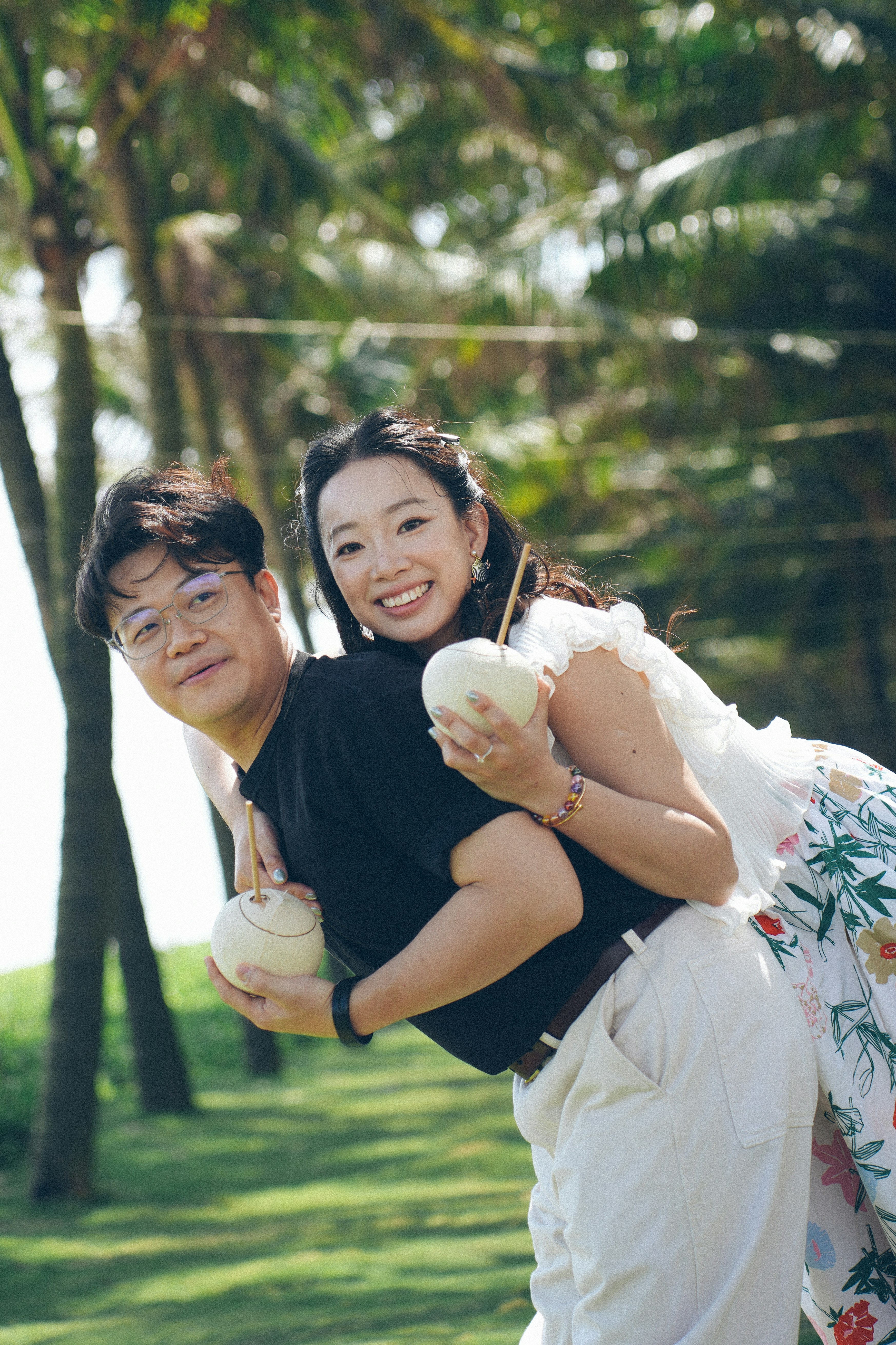 Joyful piggyback by the palms under tropical light