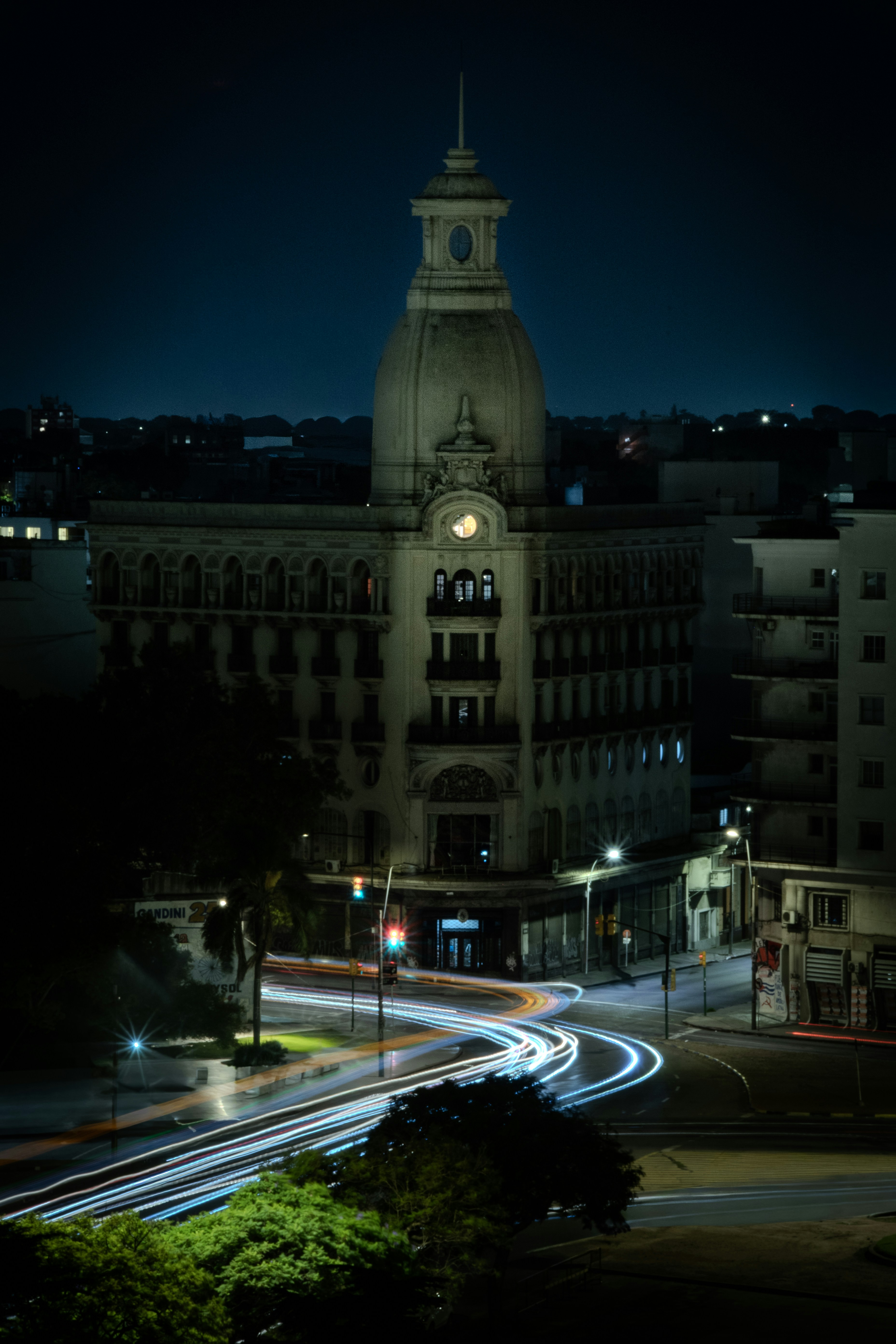 Nighttime Facade: A Carved Clocktower Crowned with Streaks of Neon Light