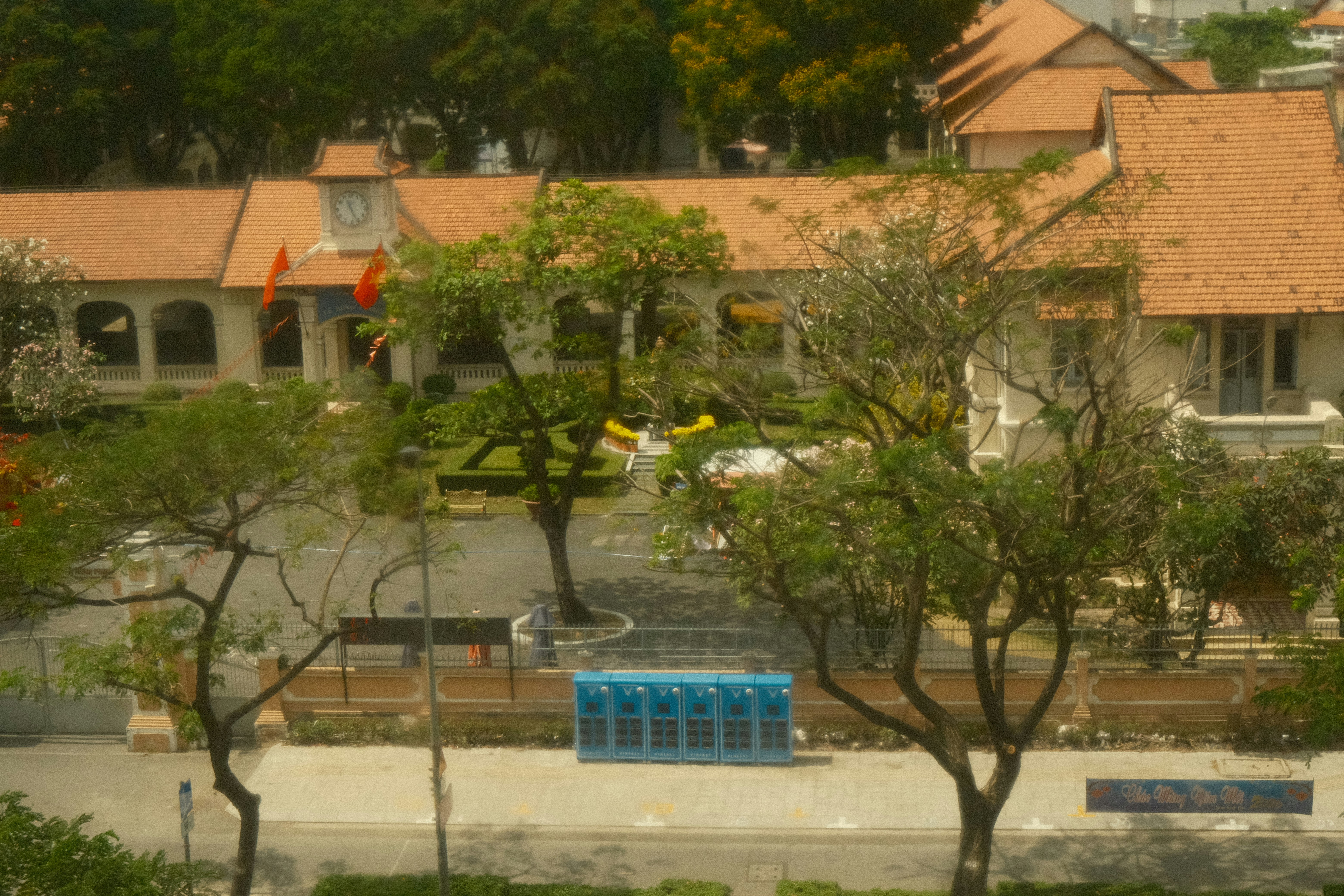 Courtyard Clock Tower and Blue Kiosk Framed by Trees