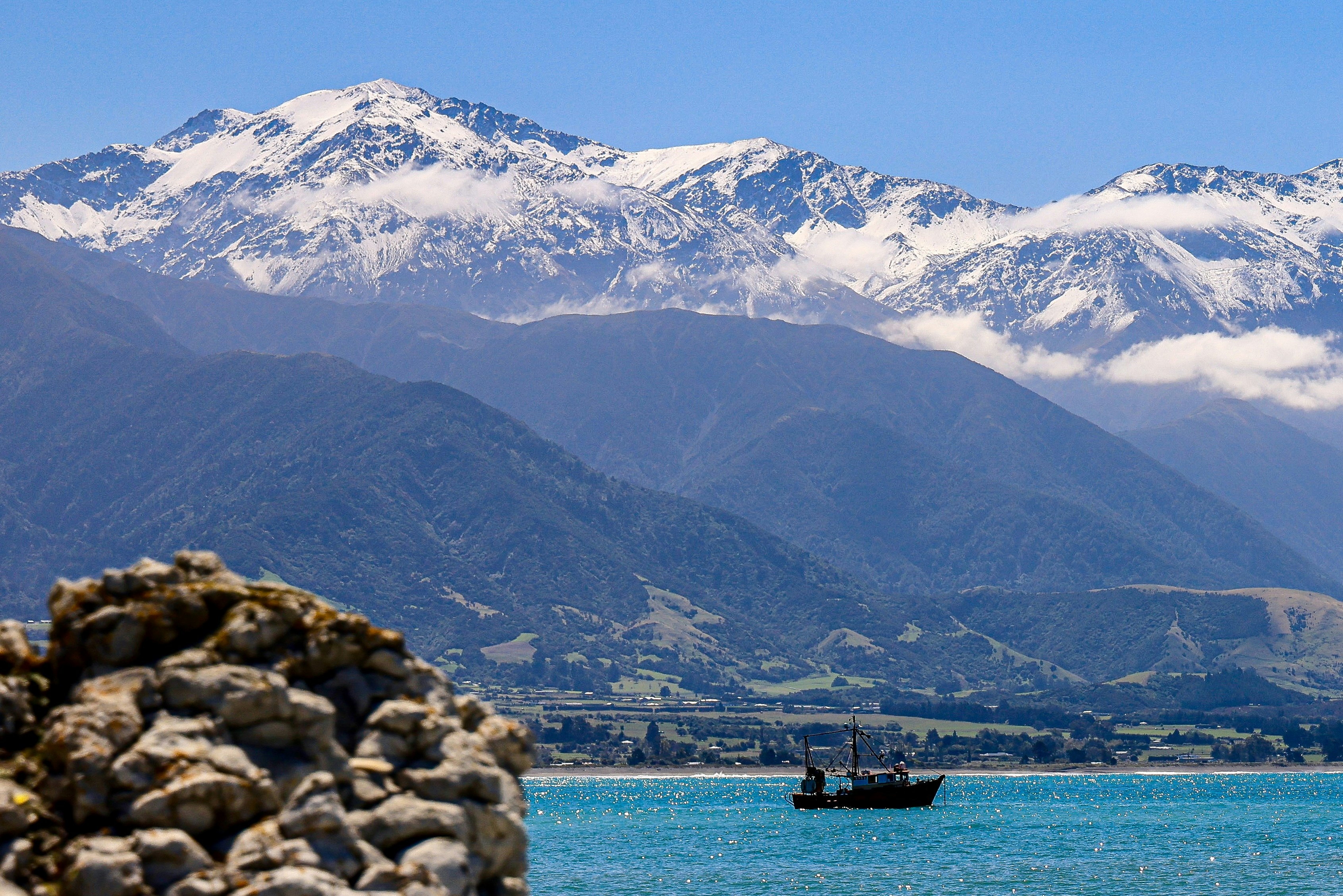 Snow-kissed peaks over a tranquil lake