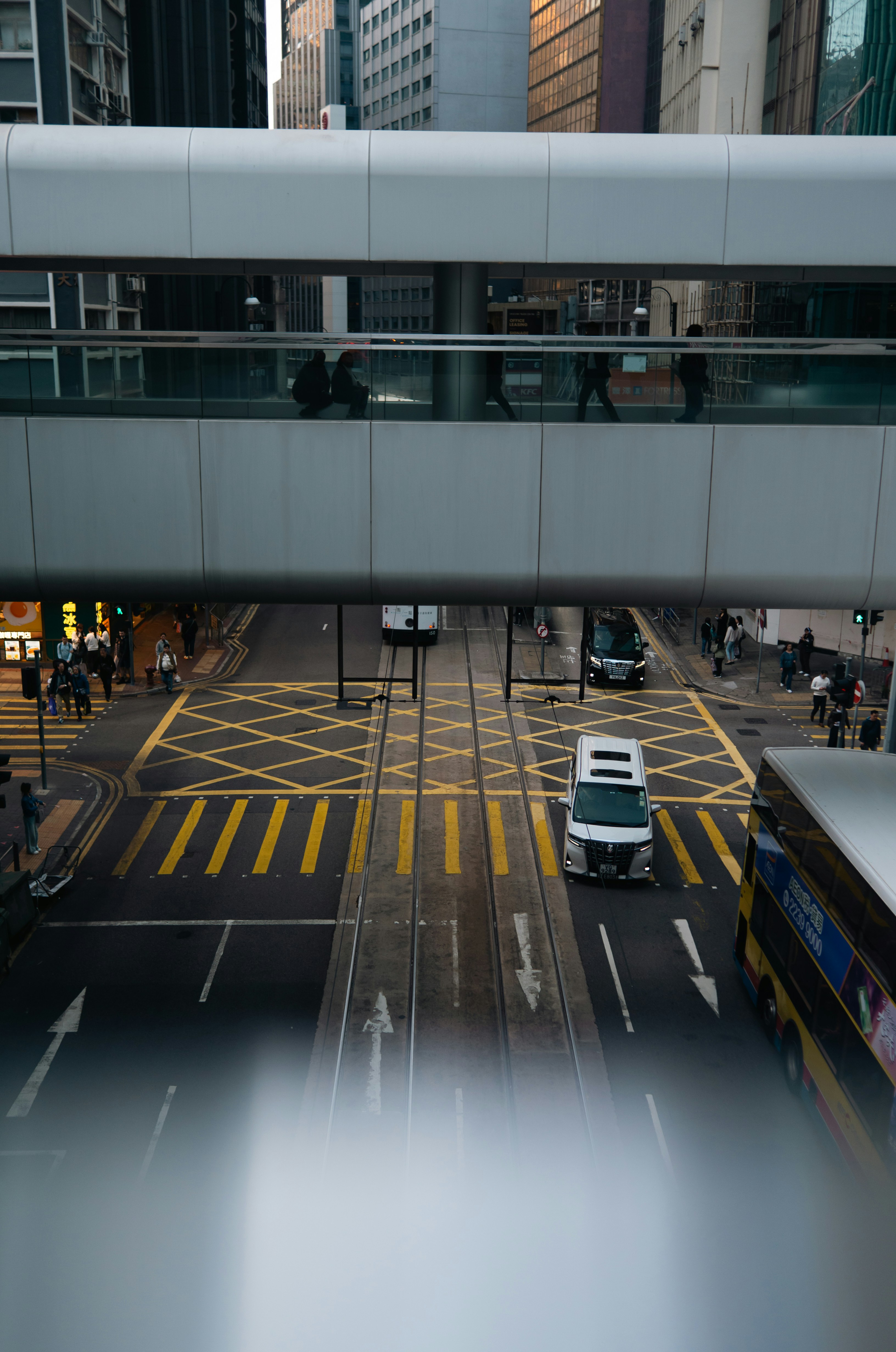 Pedestrian bridge over a busy city street with traffic.