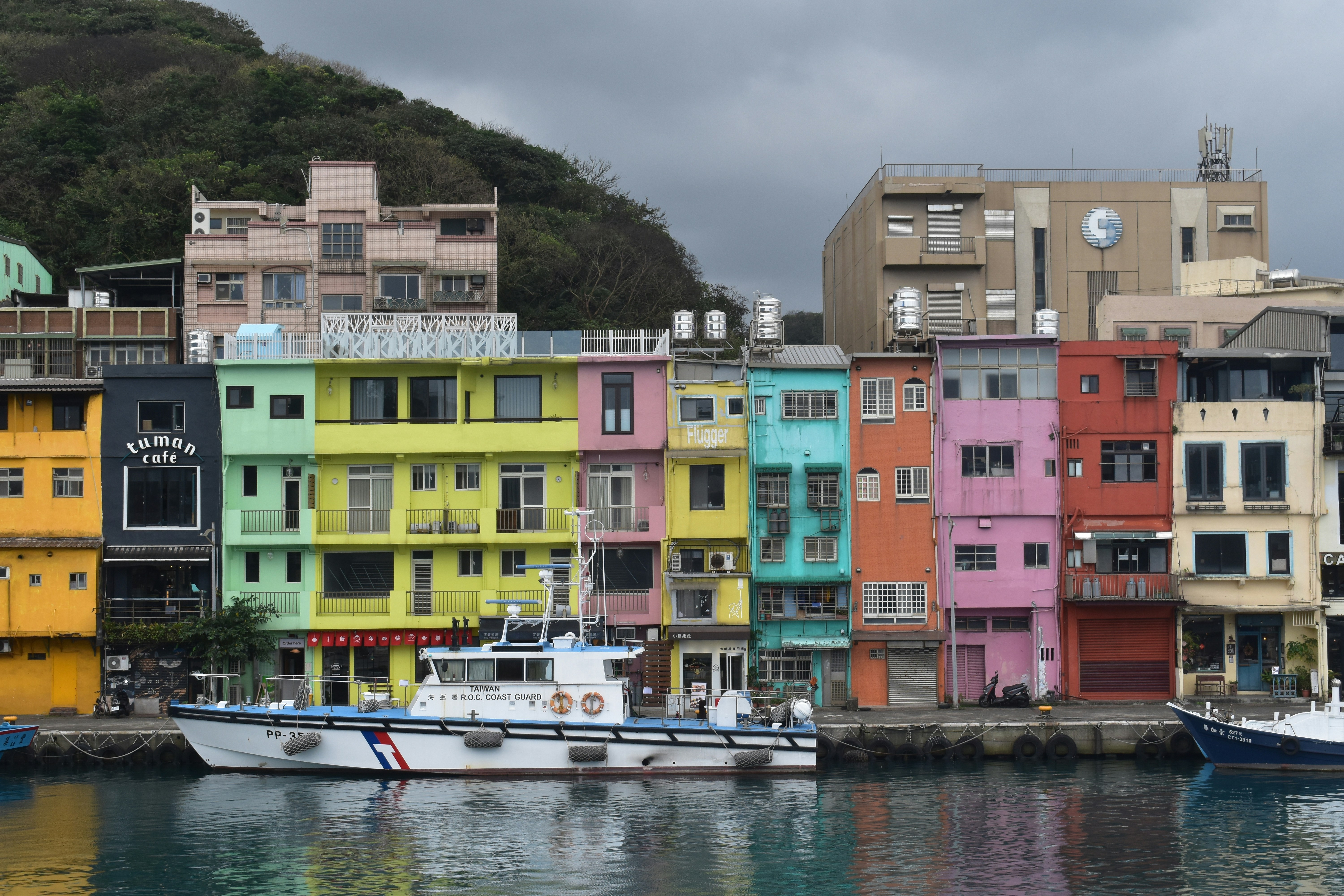 Rainbow Row by the Harbor: Colorful Waterfront Homes Reflected in Calm Waters