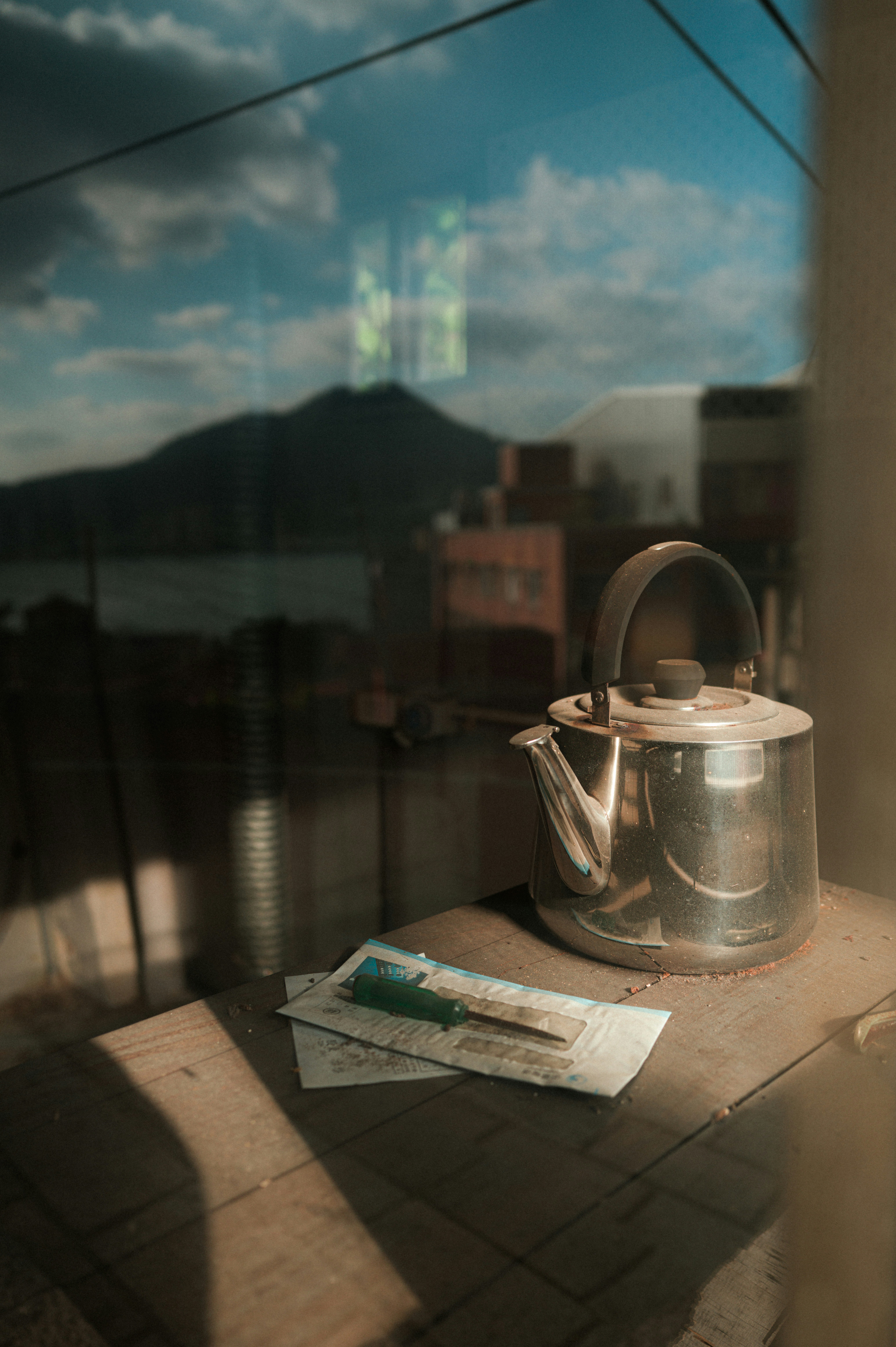 Skewed Evening Quiet: A Weathered Kettle and Notes