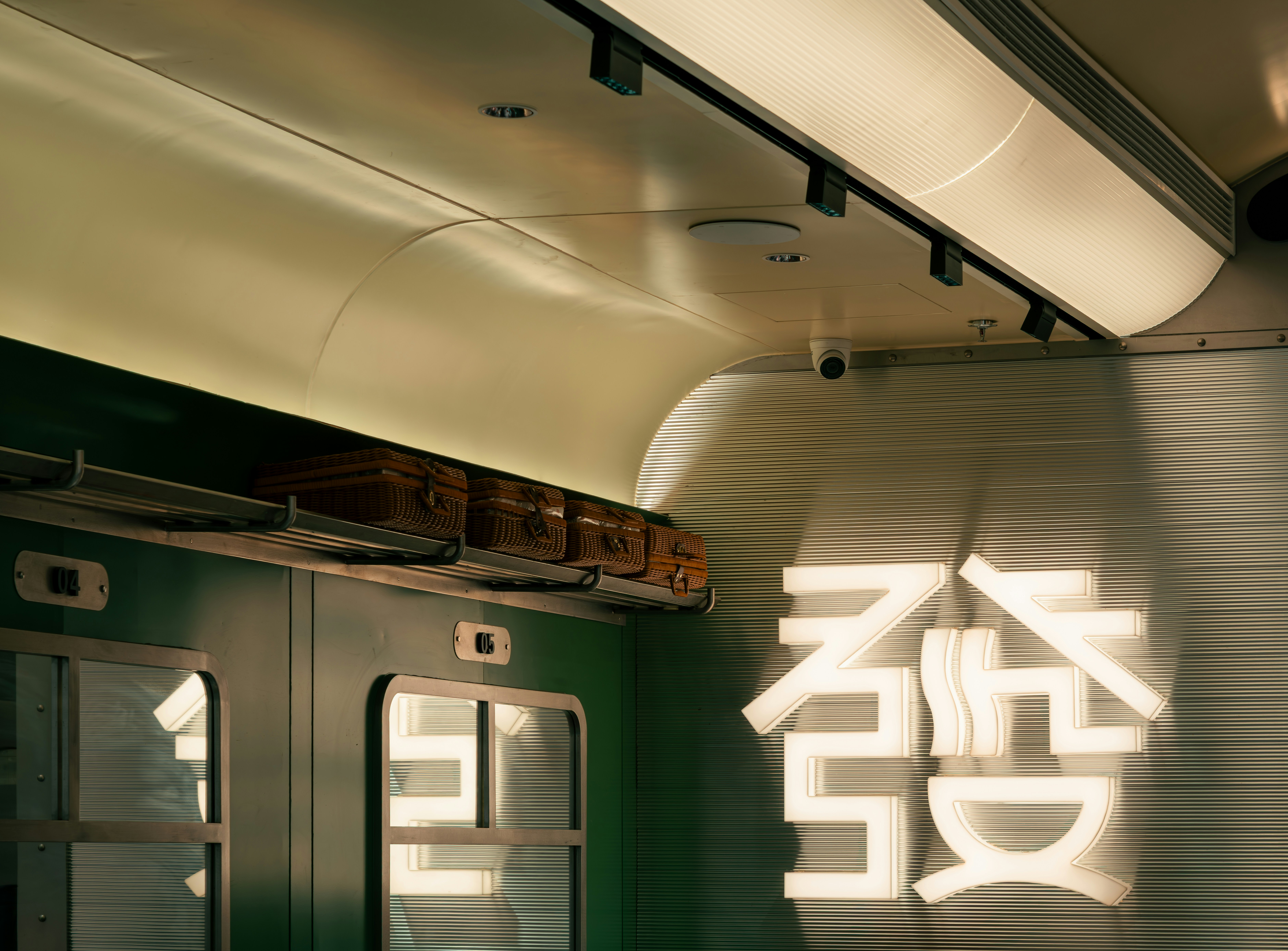 Green train carriage with illuminated chinese characters