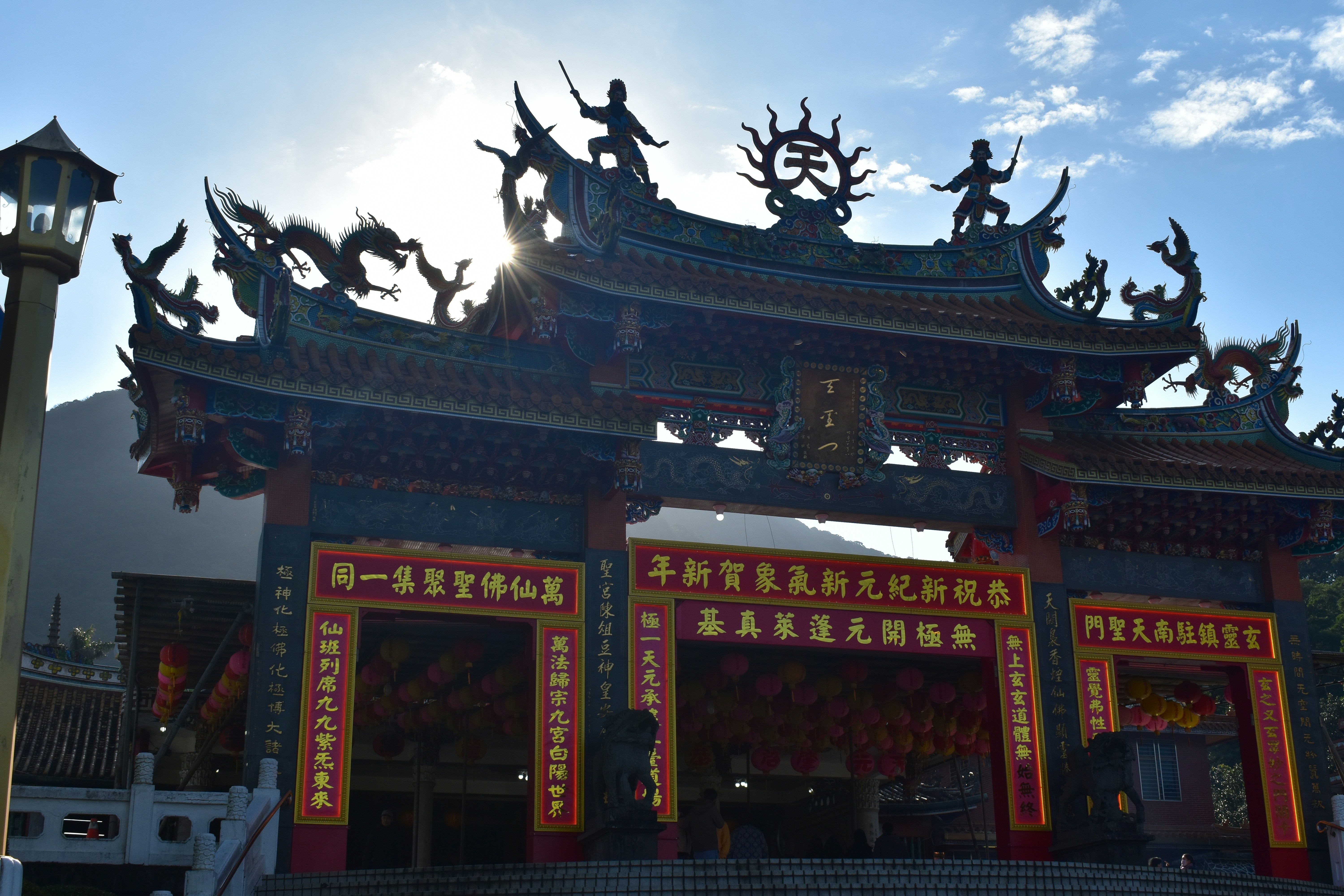 Temple Gates Under a Backlit Sky with Dramatized Roof Dragons