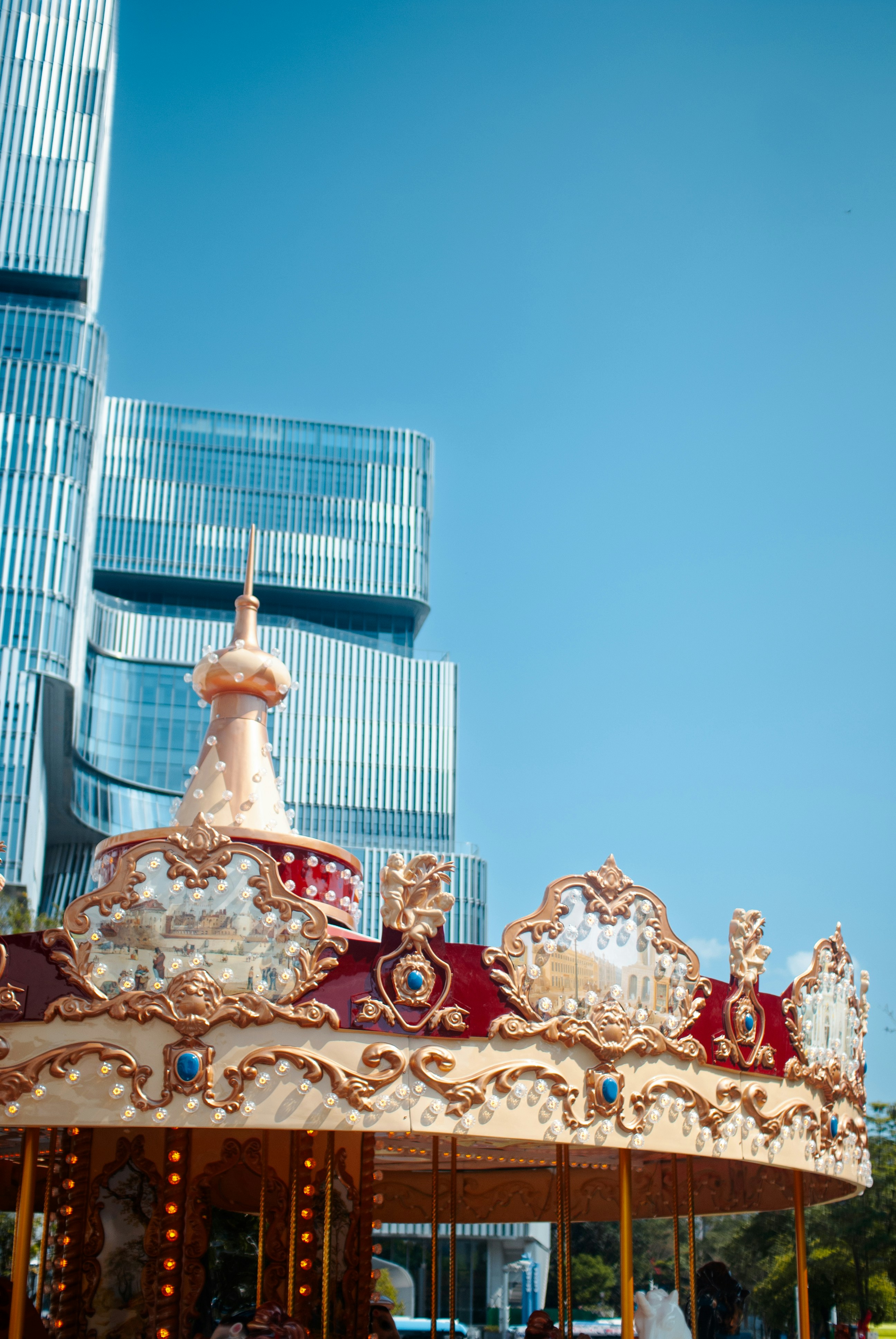 Carousel Adornments Quietly Tug at the Sky Above Modern Glass