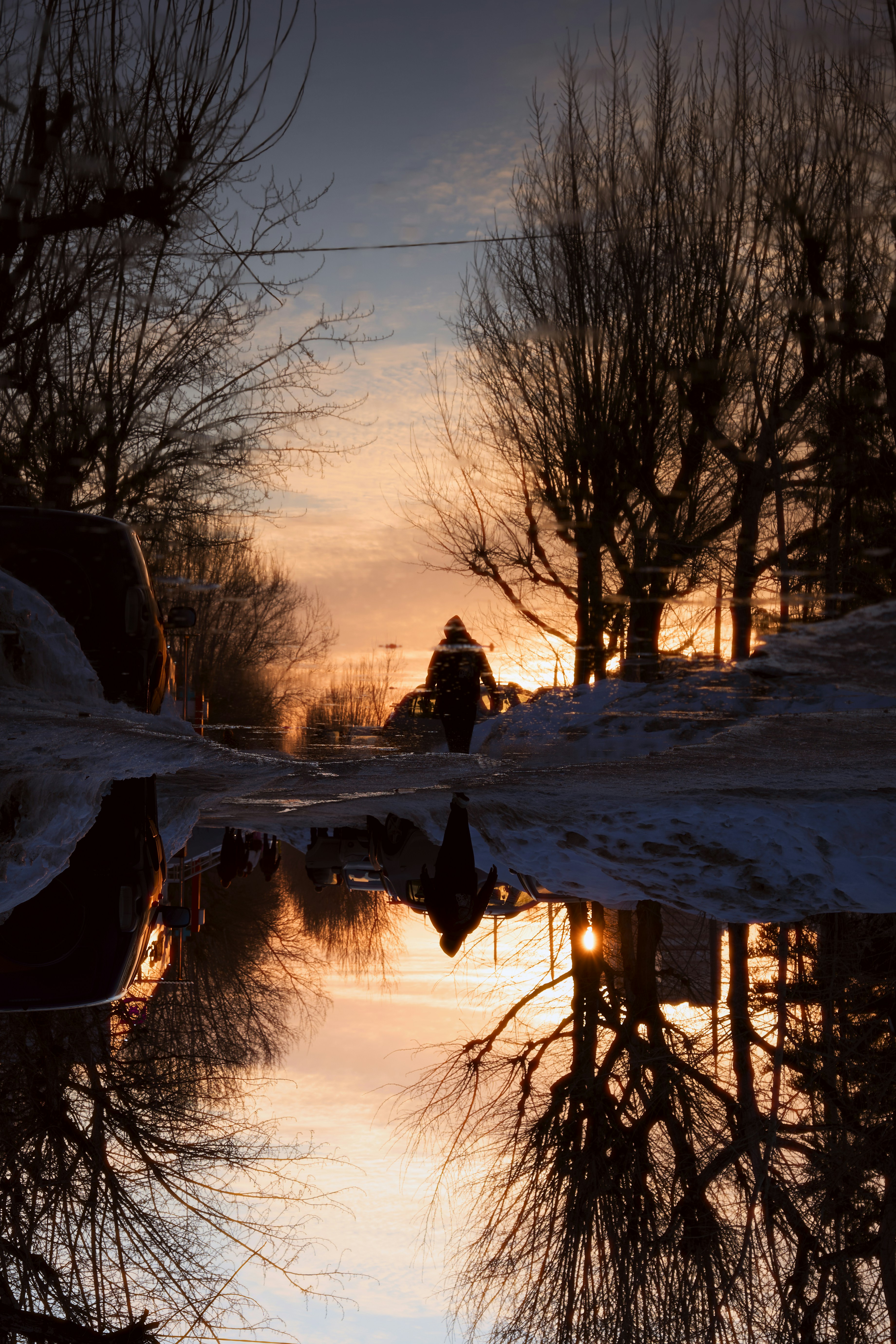 Sunset Silhouette Over a Snowlined Street