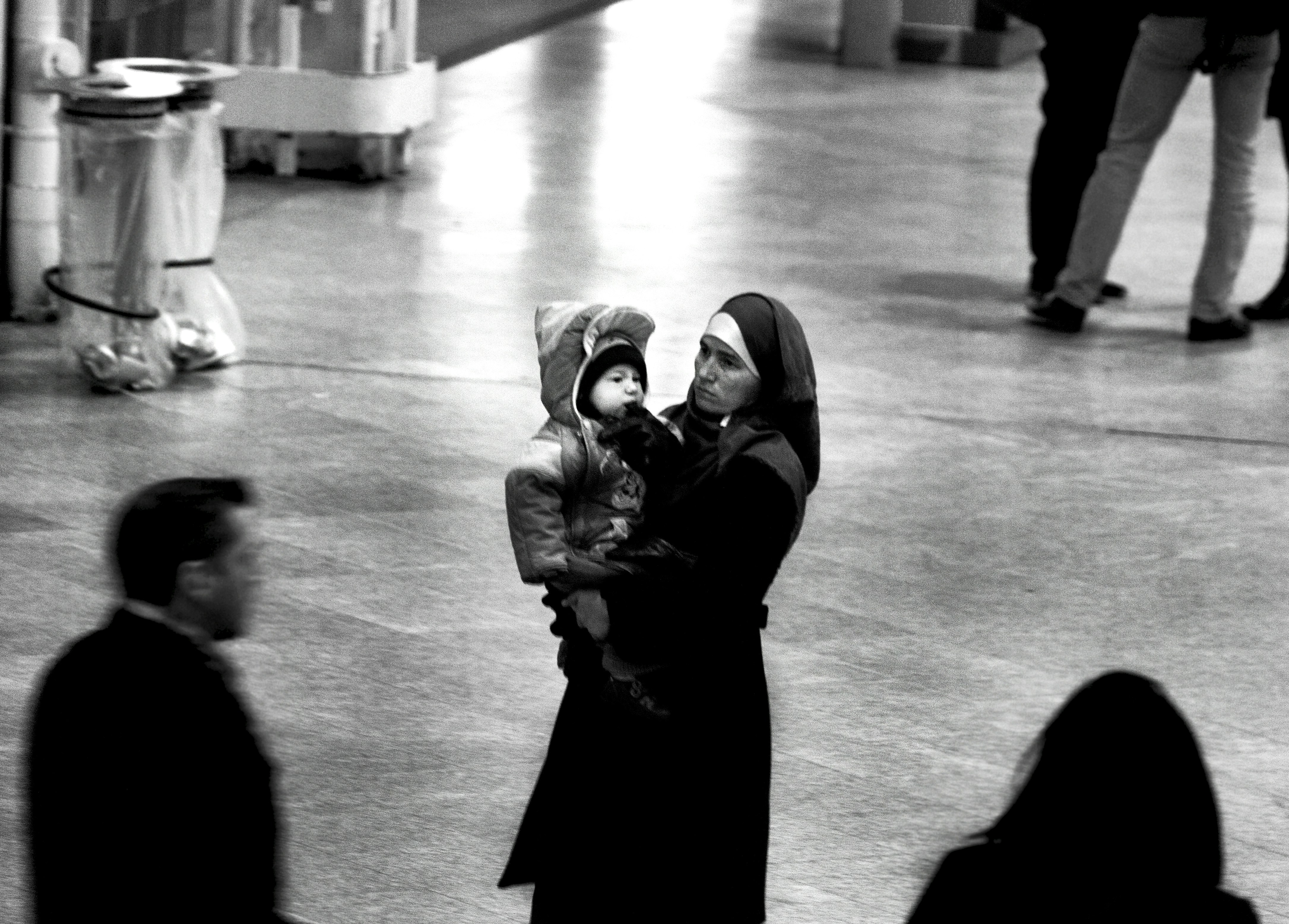 Mother in a Cathedral of Steel: A Quiet Moment with a Small Child