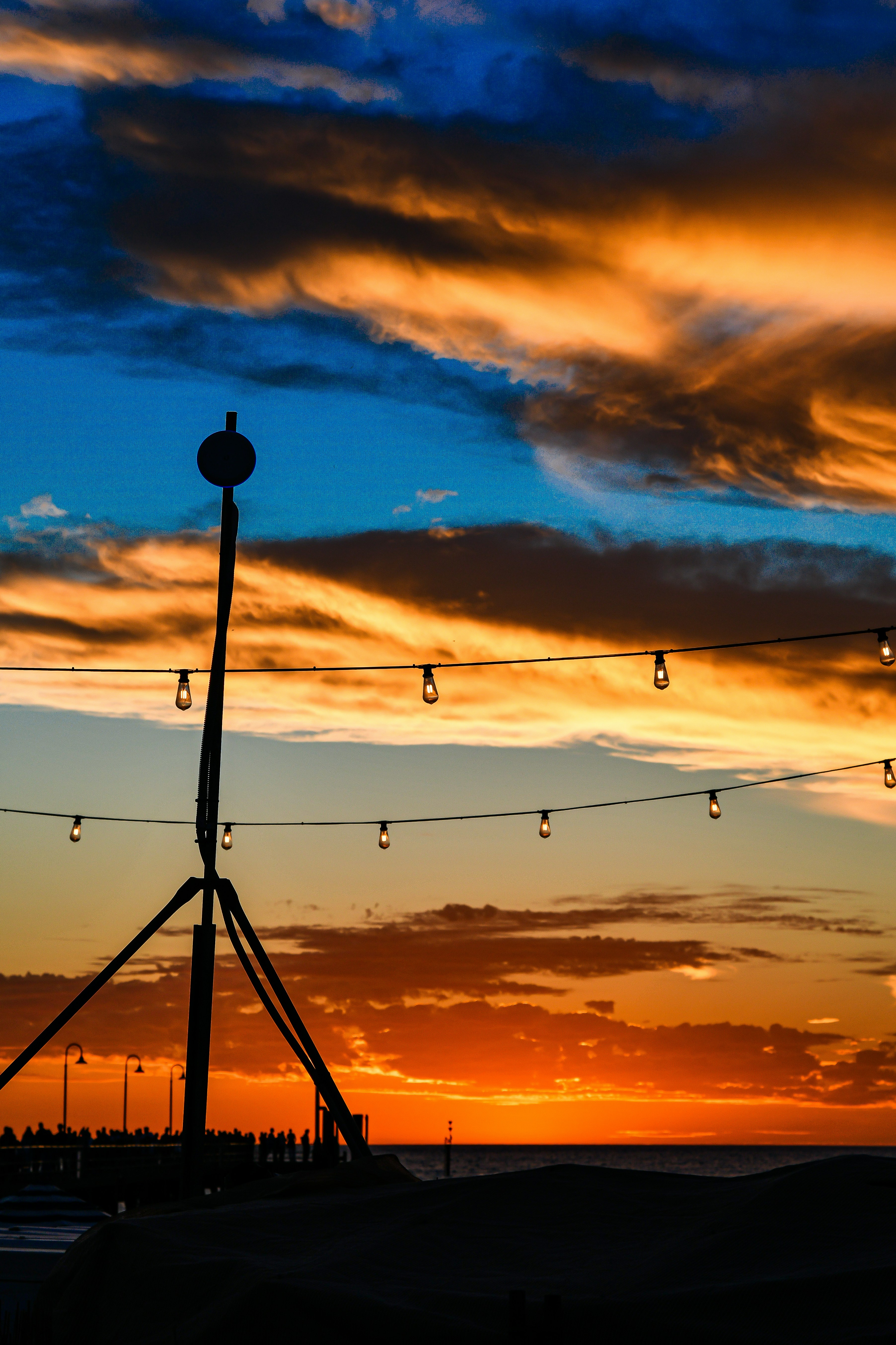 Silhouetted Lighthouse Structure Against a Fiery Dusk