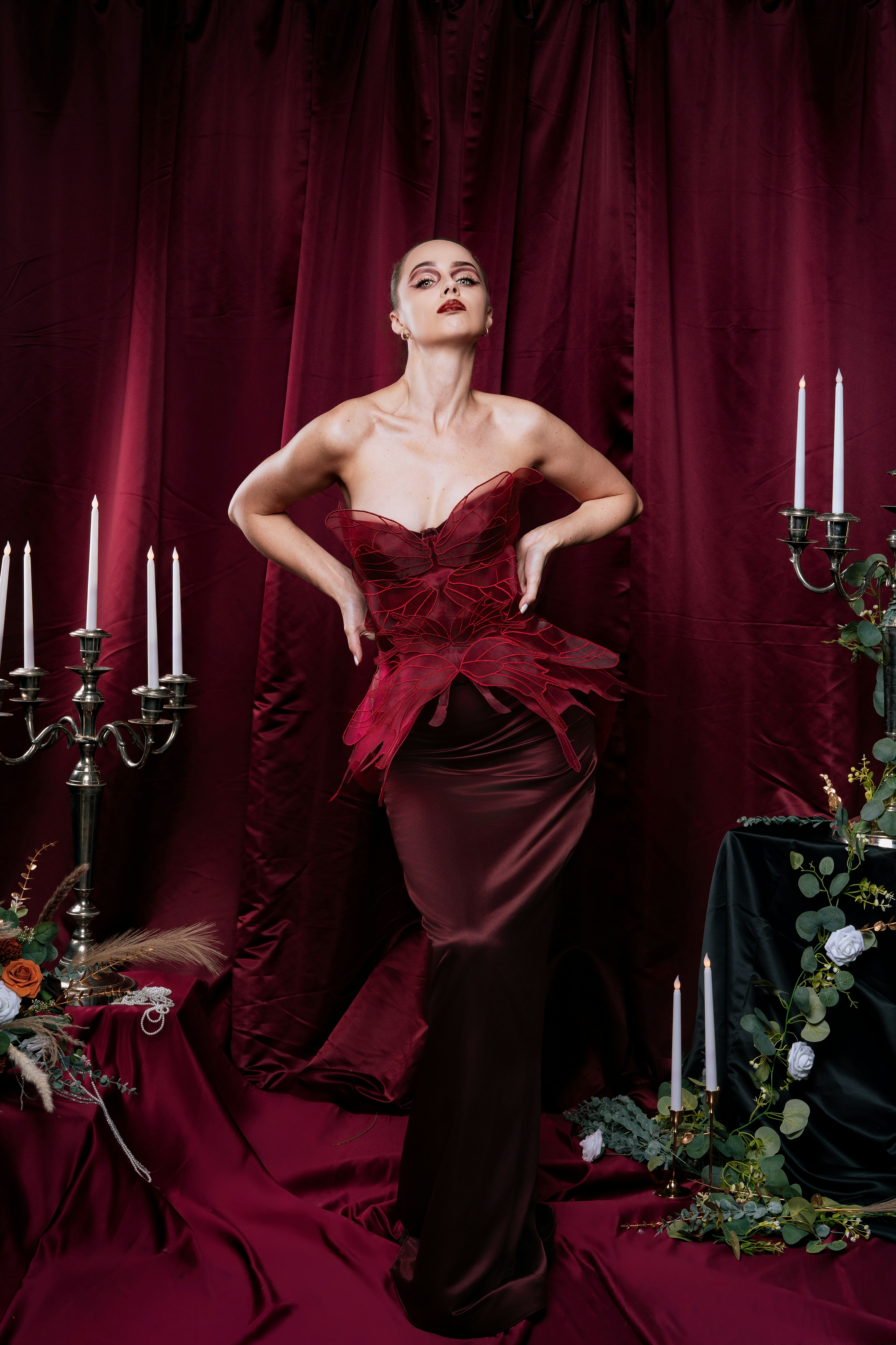 Red Velvet Veil: A Daring Pose Beneath Velvet Drapery