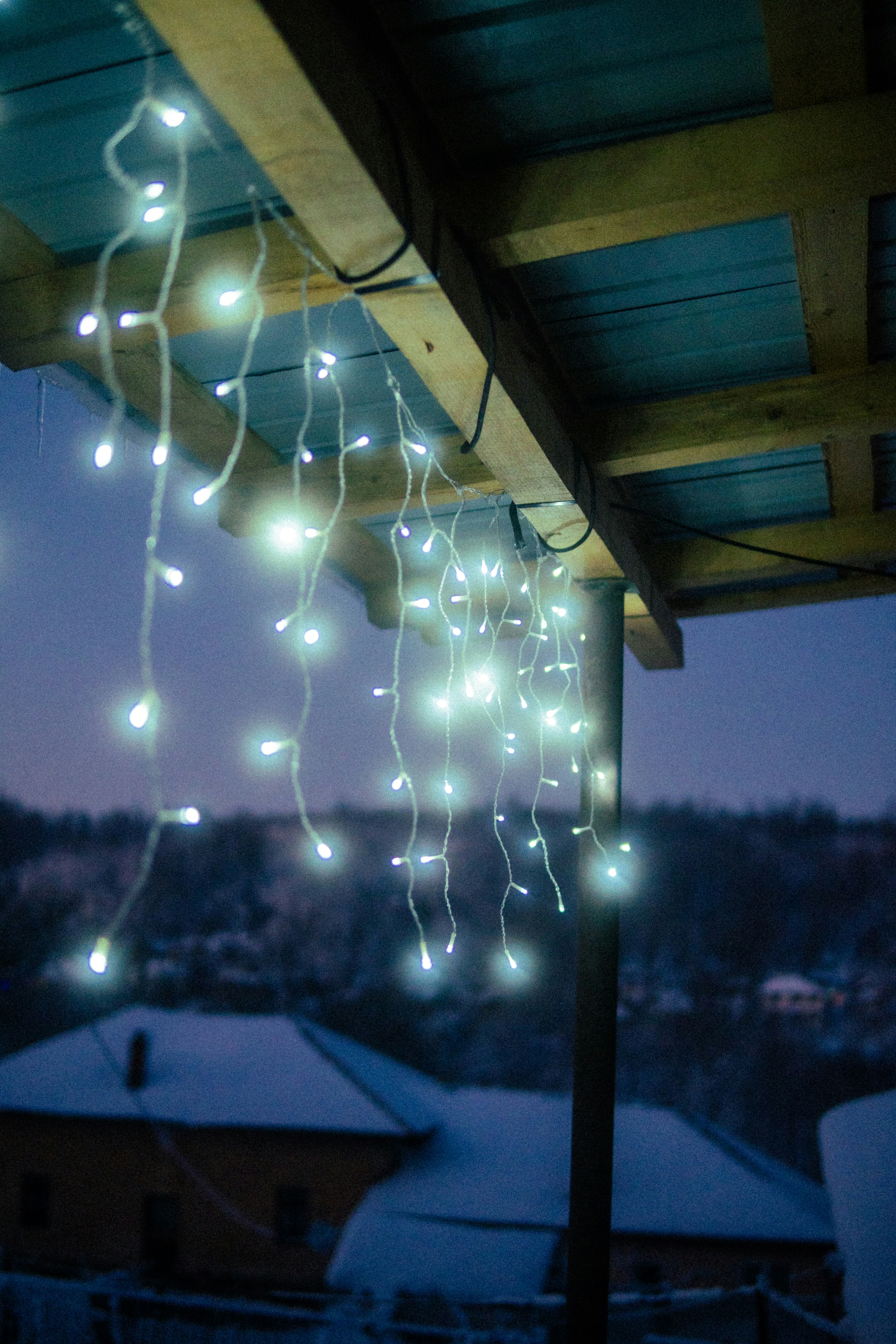 Twinkling String Lights Under a Snowy Evening Porch