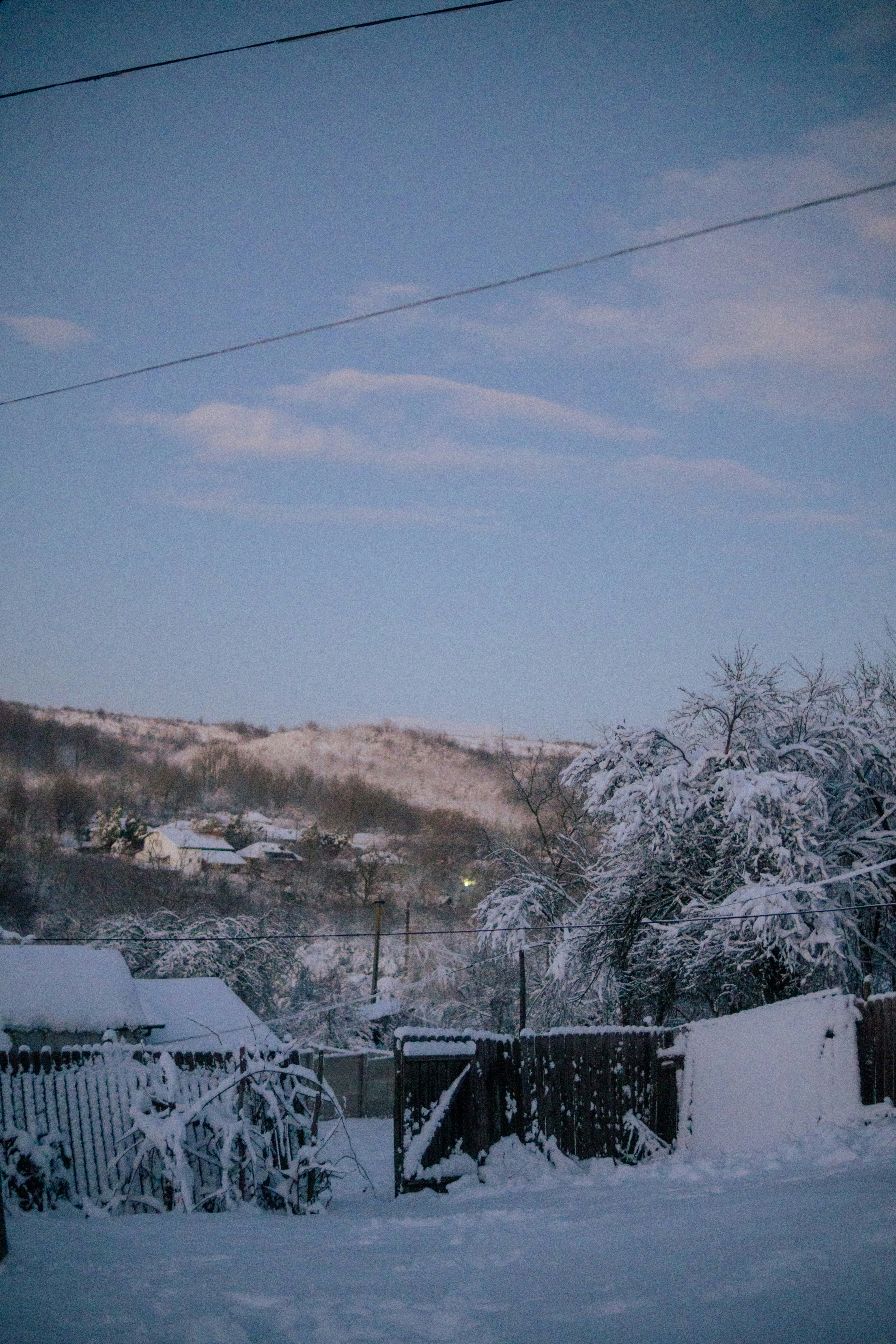 Snowbound Quiet: A Rural Winter Scene Under Clear Blue Sky