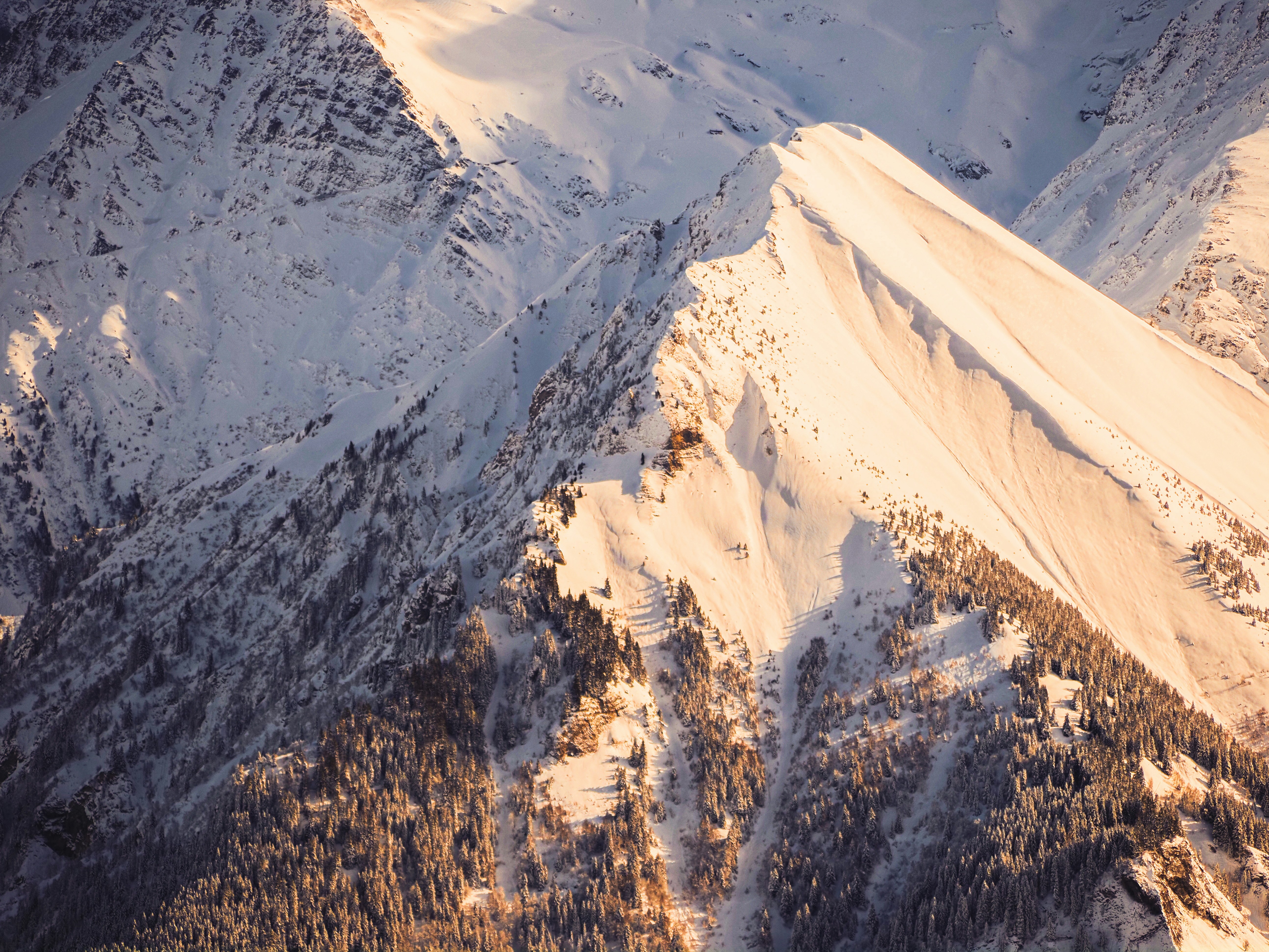Golden Ridge: Snow-stitched Peaks Beneath Low-angled Sun