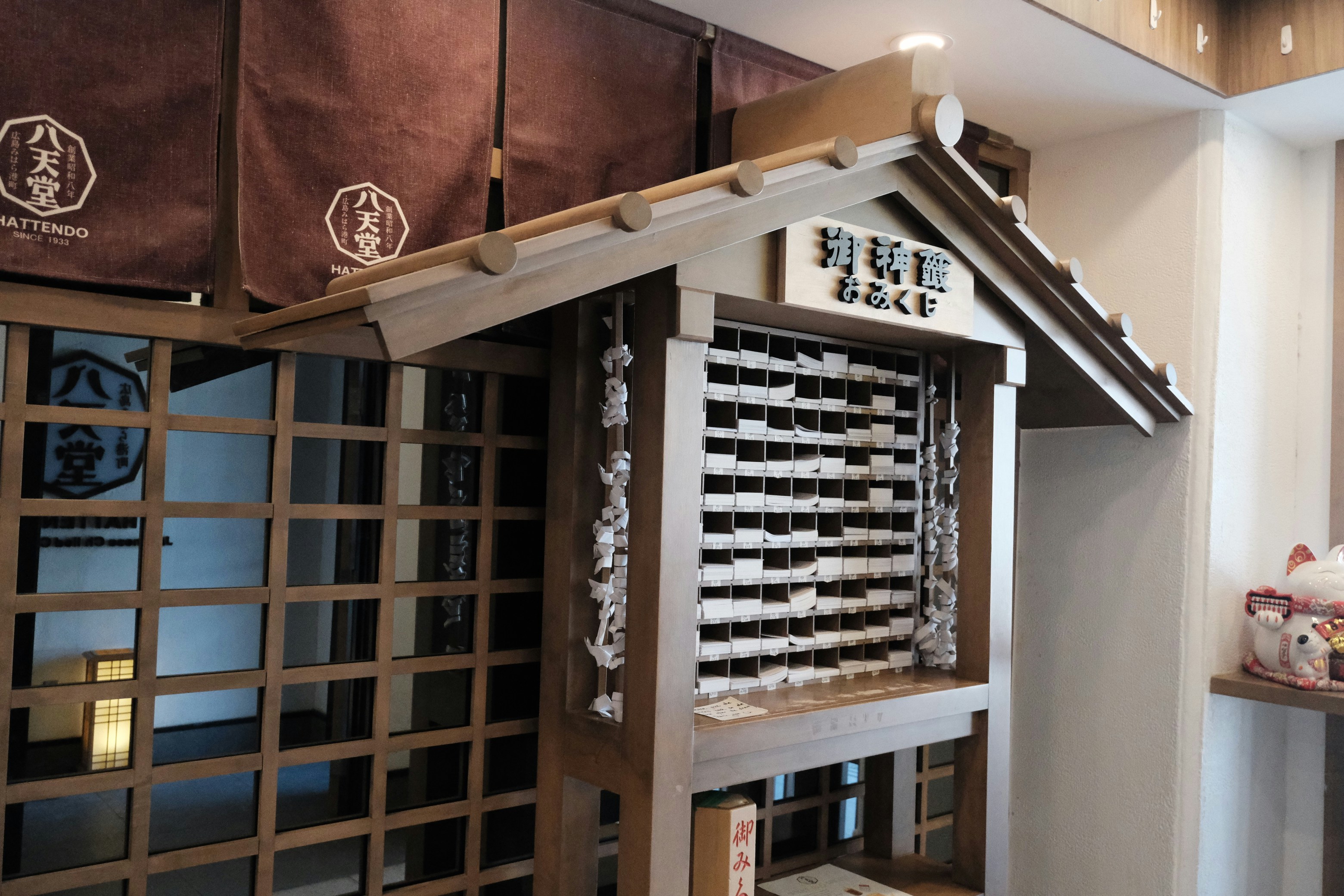 Miniature Shinto Shrine Nook tucked beside a wooden lattice