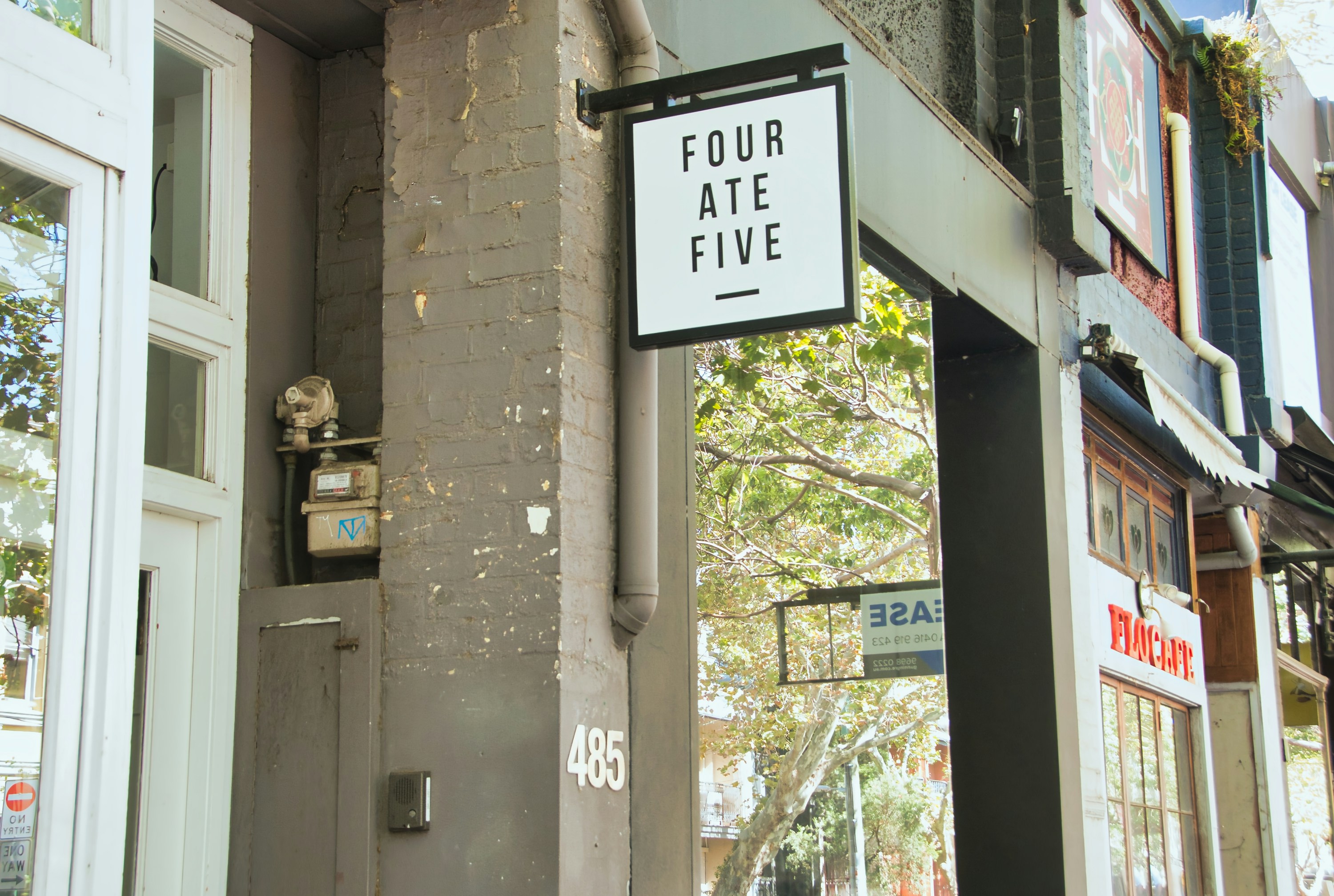 Four Ate Five: Street-scene Signage with a Corridor of Shops