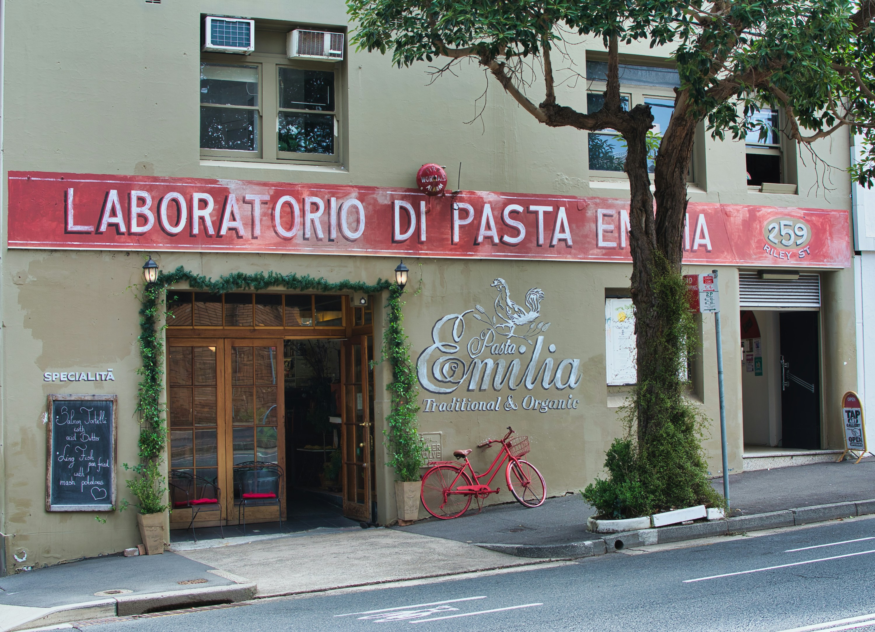 Red Pasta Lab: A Corner Café with a Vintage Bicycle and Italian Signage