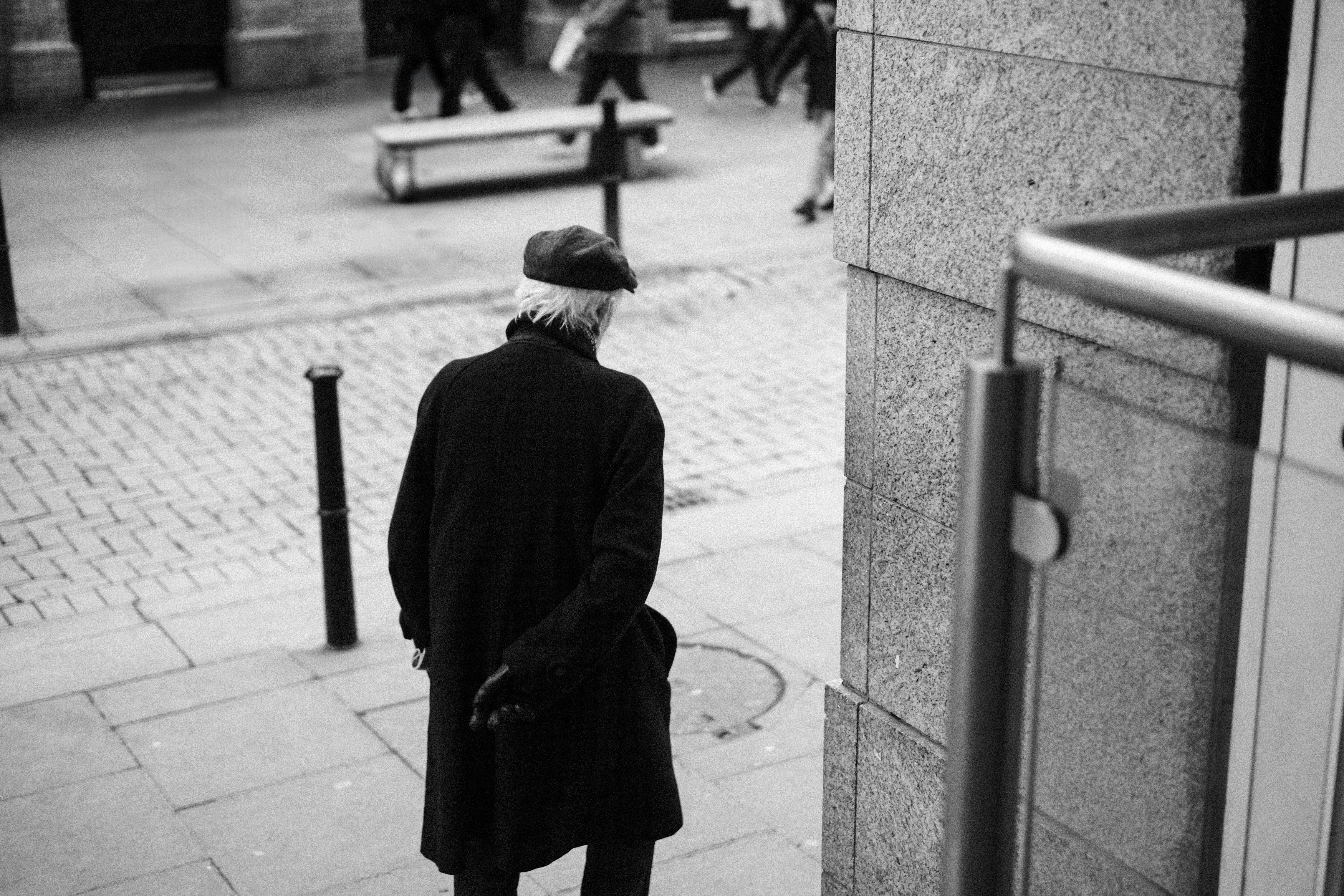 An Ongoing Pause: Elderly Gentleman in a Quiet Street