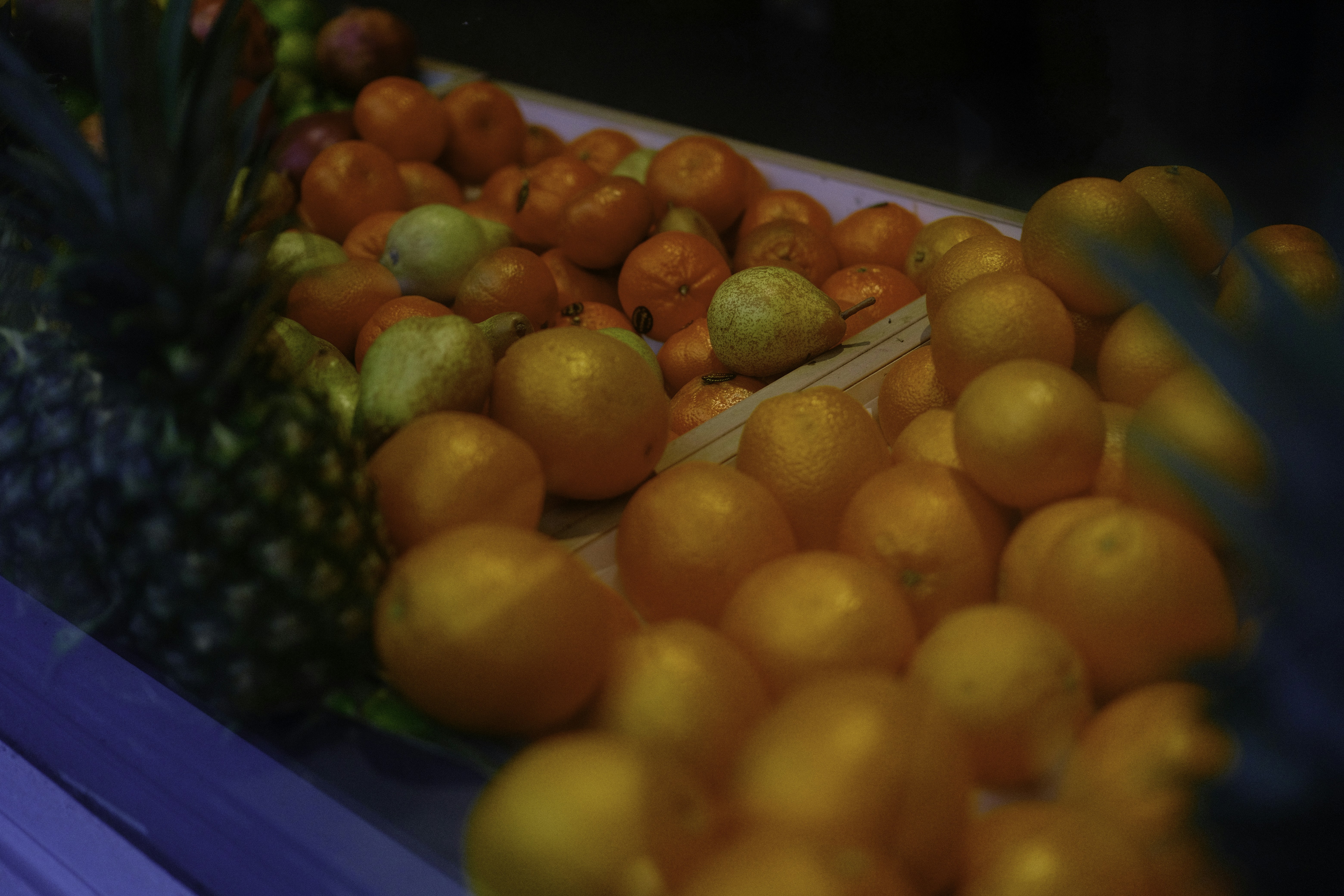 Vibrant Citrus Corner: Oranges and Pears in a Market Display