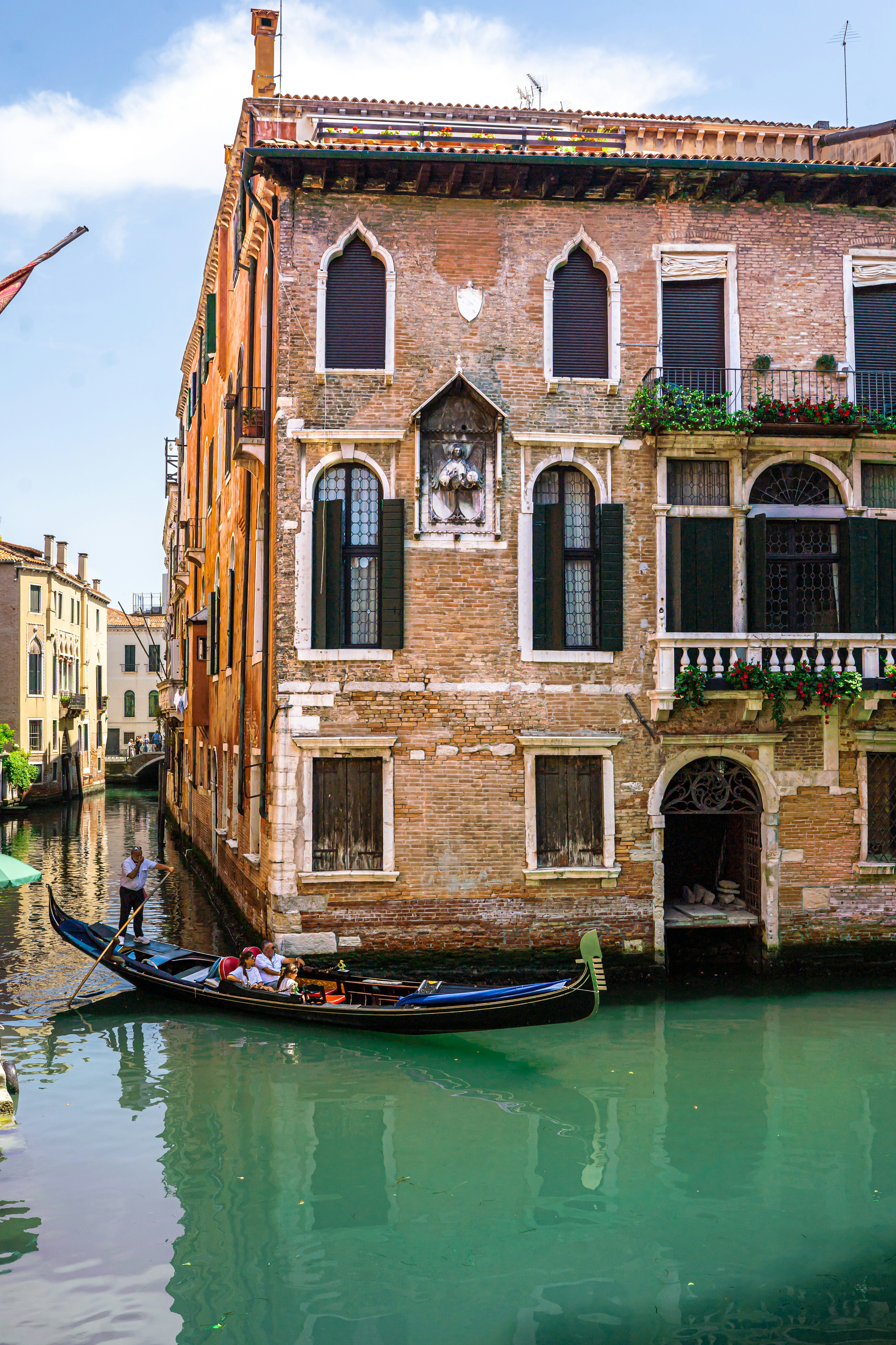 Brick Facade and Gondola along a Venetian Canal