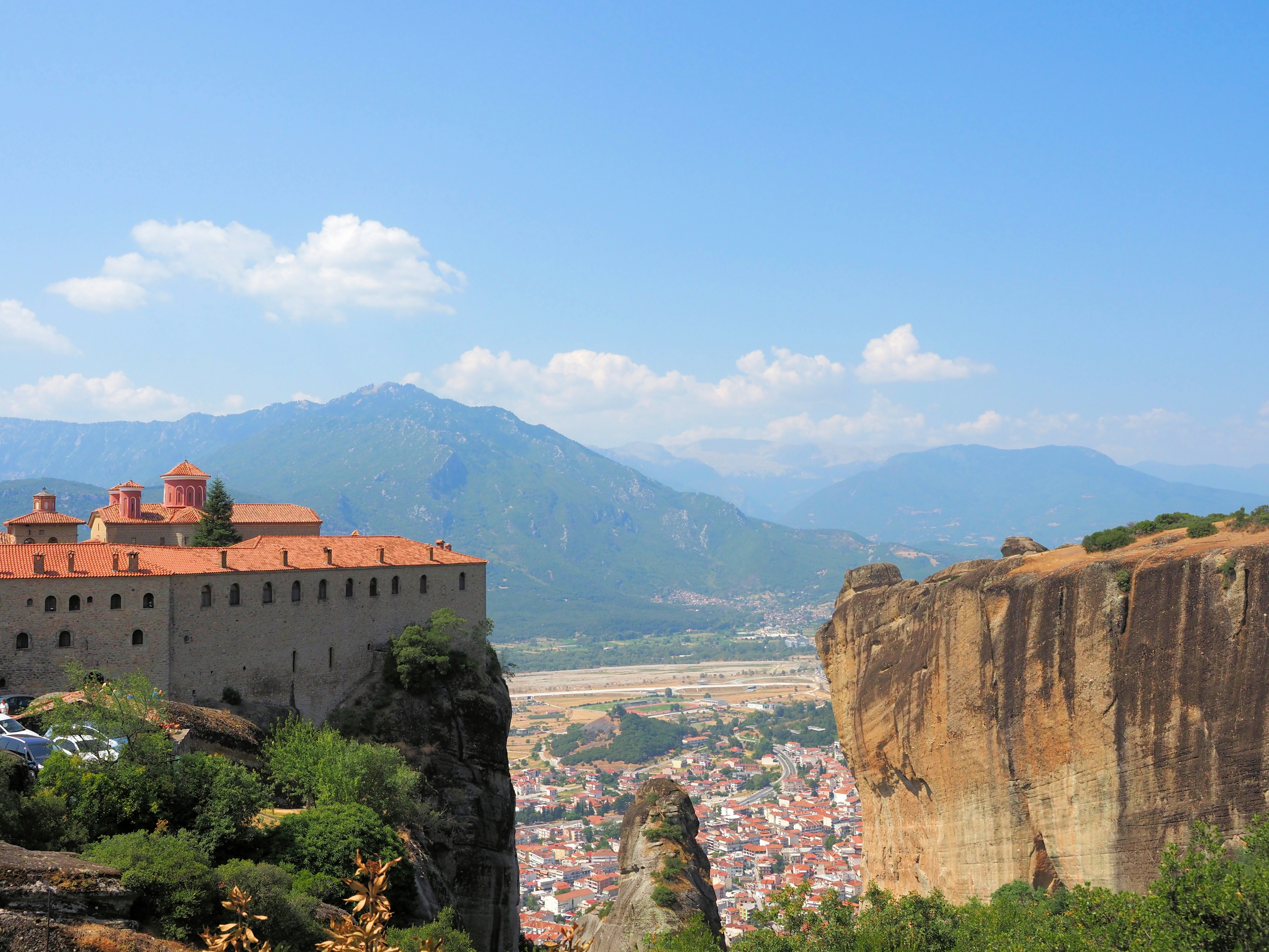 Cliffside Castle Overlooking a Valley Town