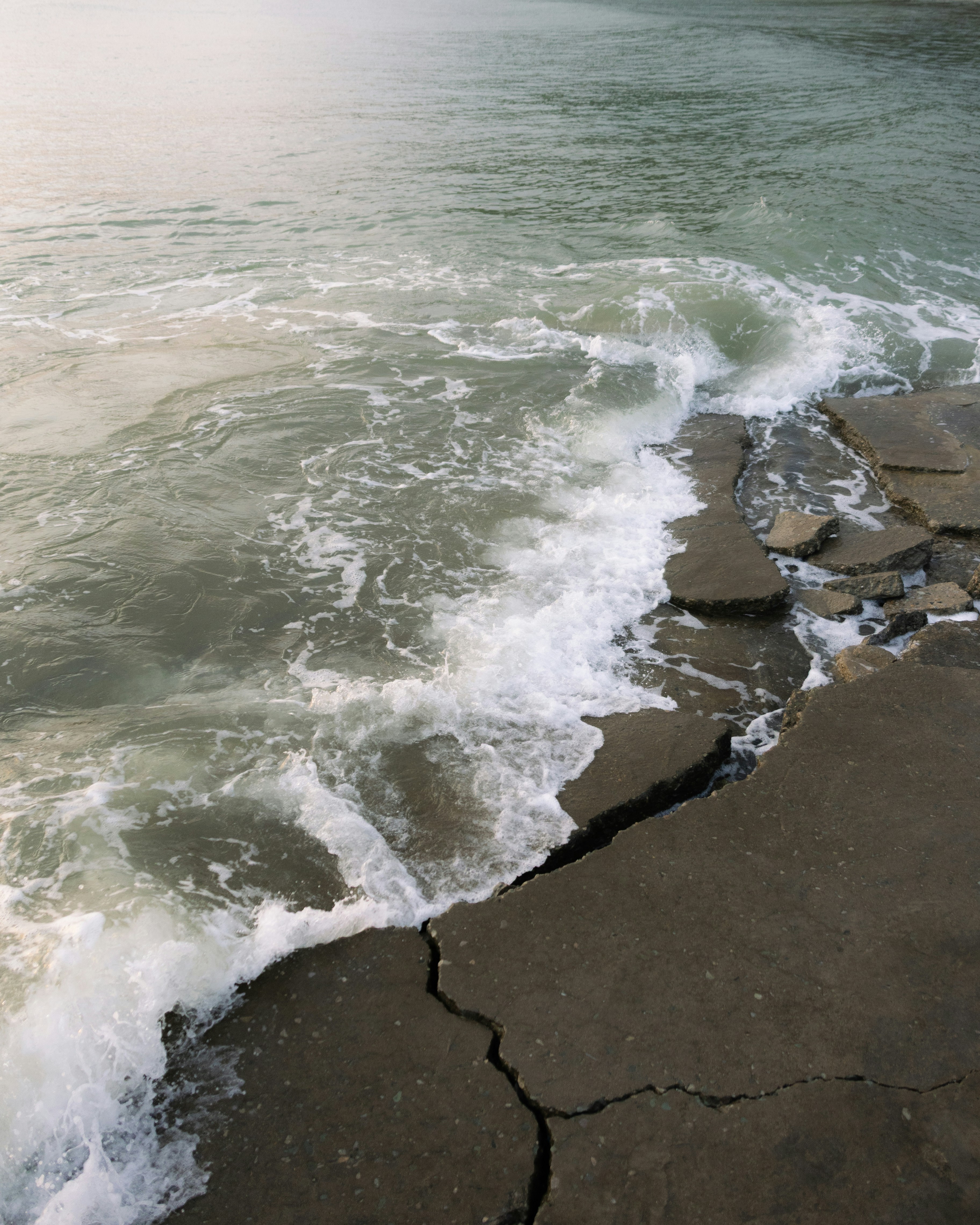 Cracked limestone leading into a restless sea