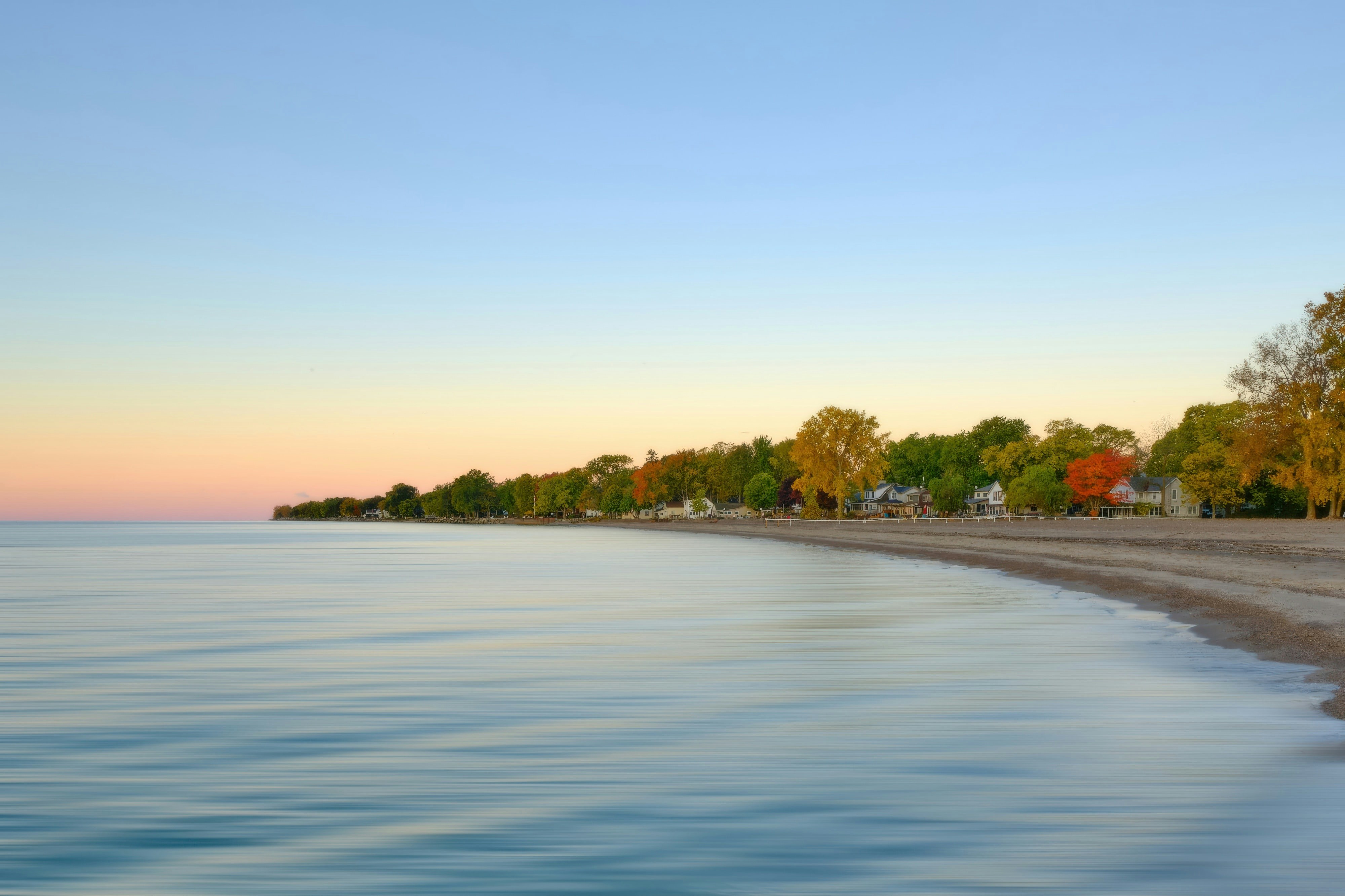 Dusk-Lit Lakeshore: Calm Waters and Fall Colors