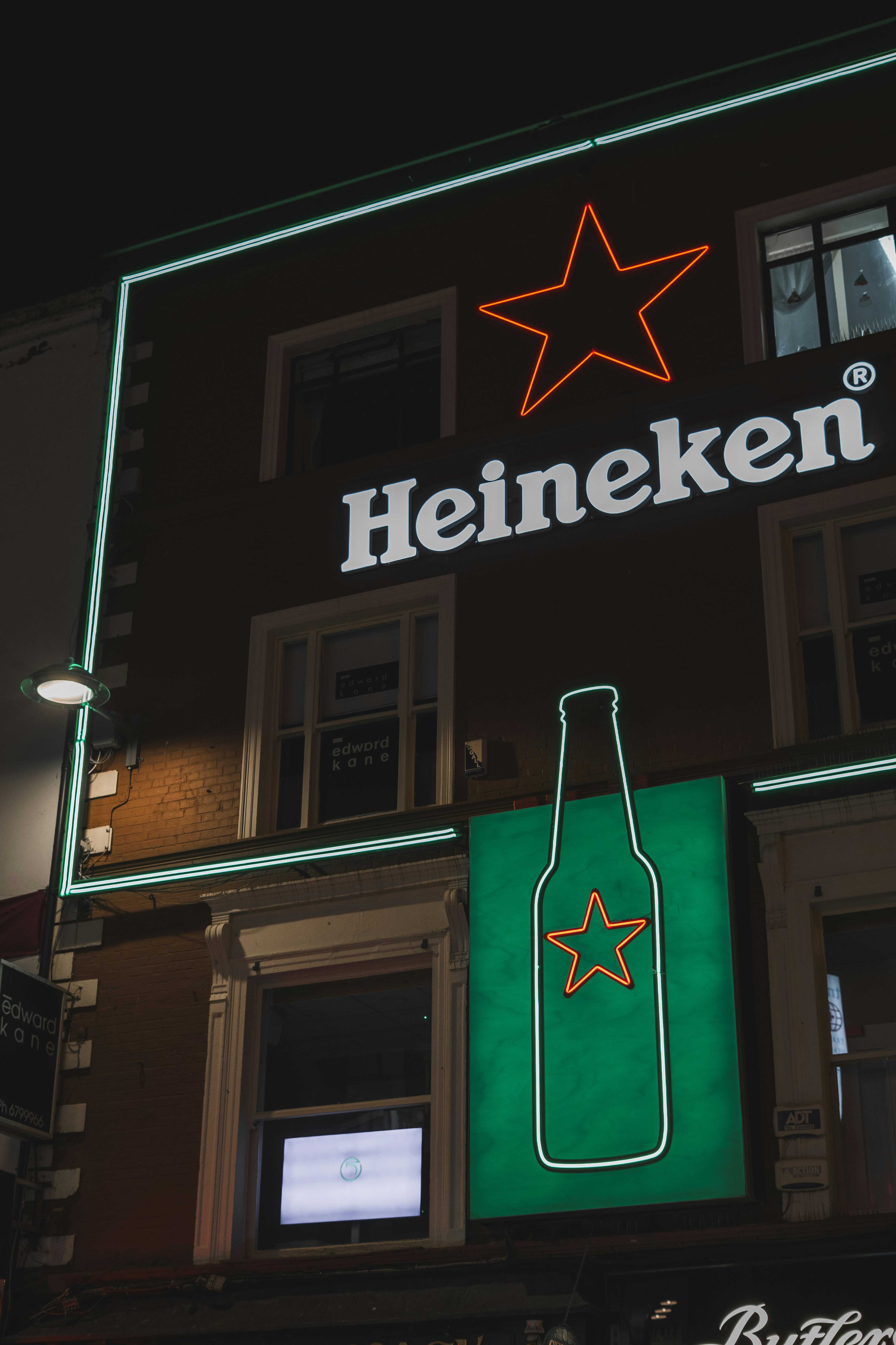 Neon Heineken: Night Facade of glowing Star and Bottle Sign