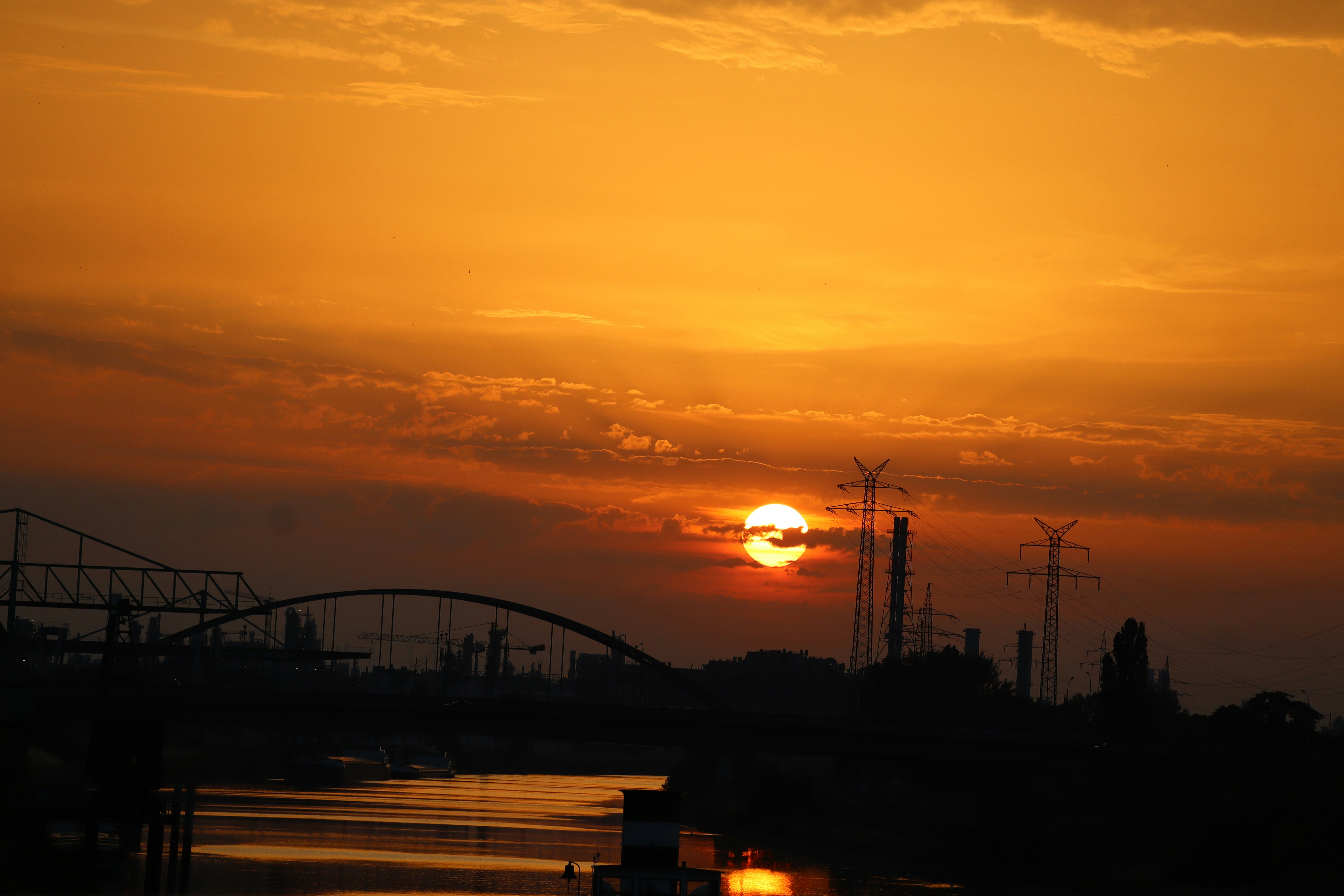 Sunset over the Quiet River: industrial silhouettes at dusk