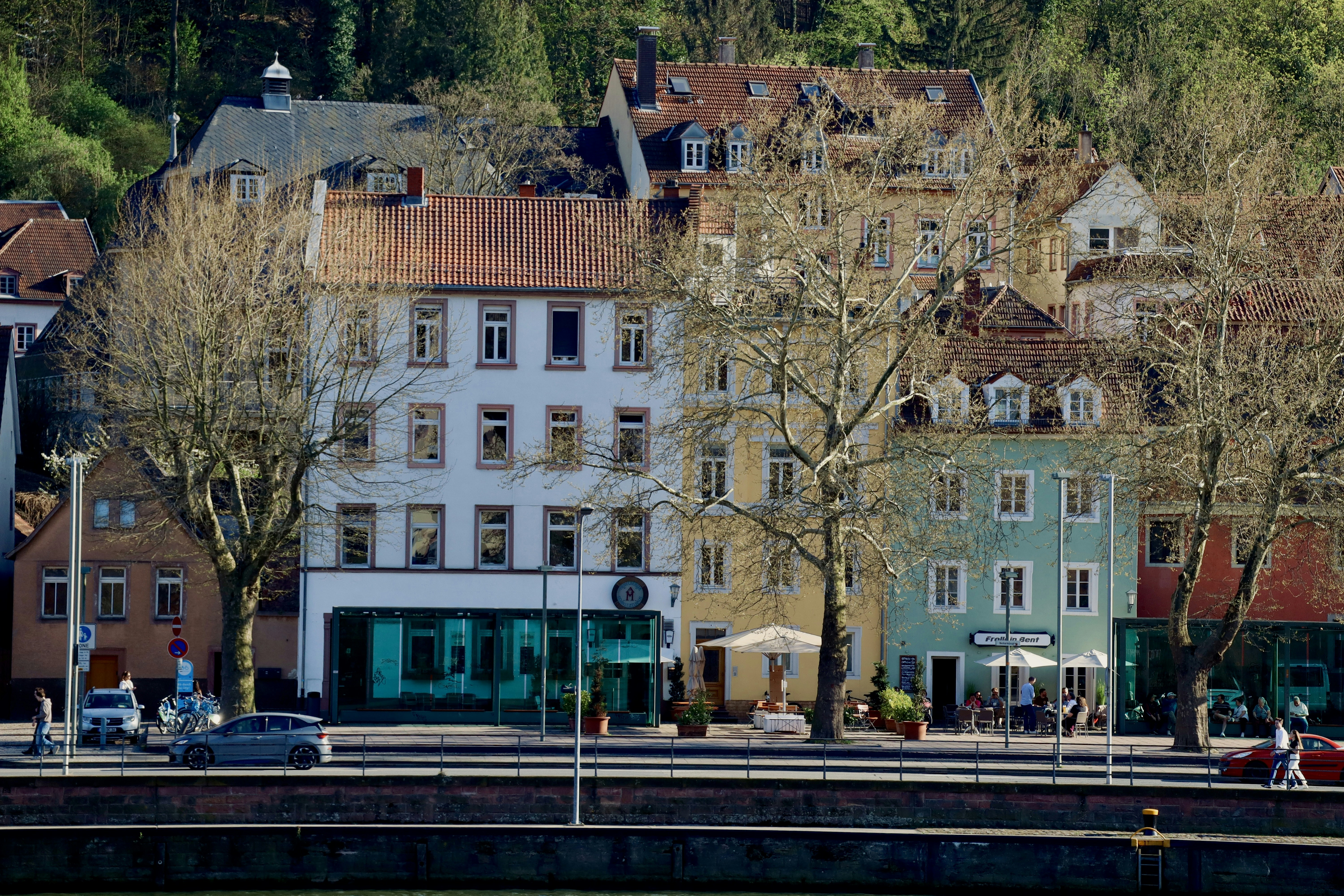 Colorful riverside row of townhouses by a bustling quay