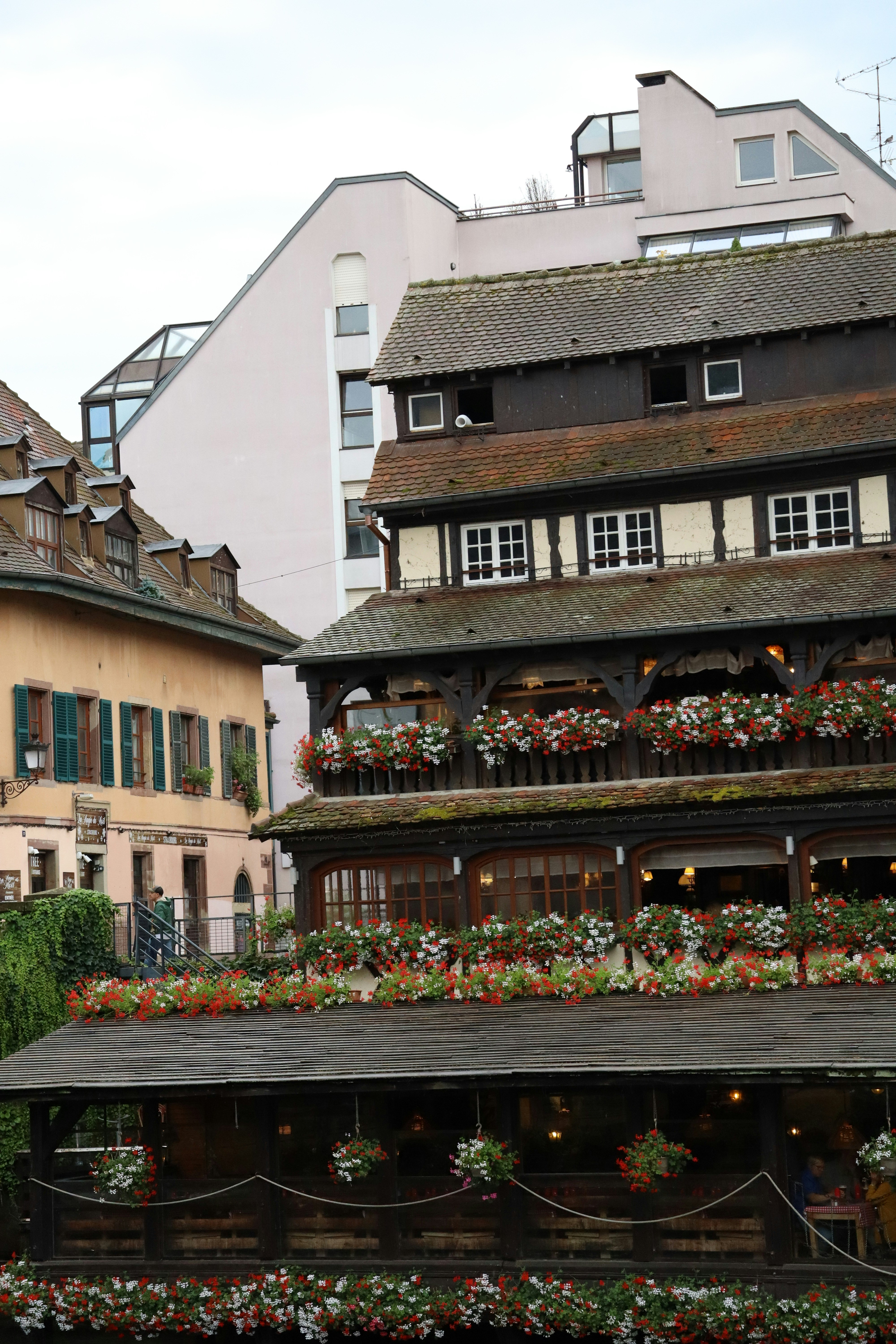 Flowered Balcony Overlook in a European Alleyway Cafe