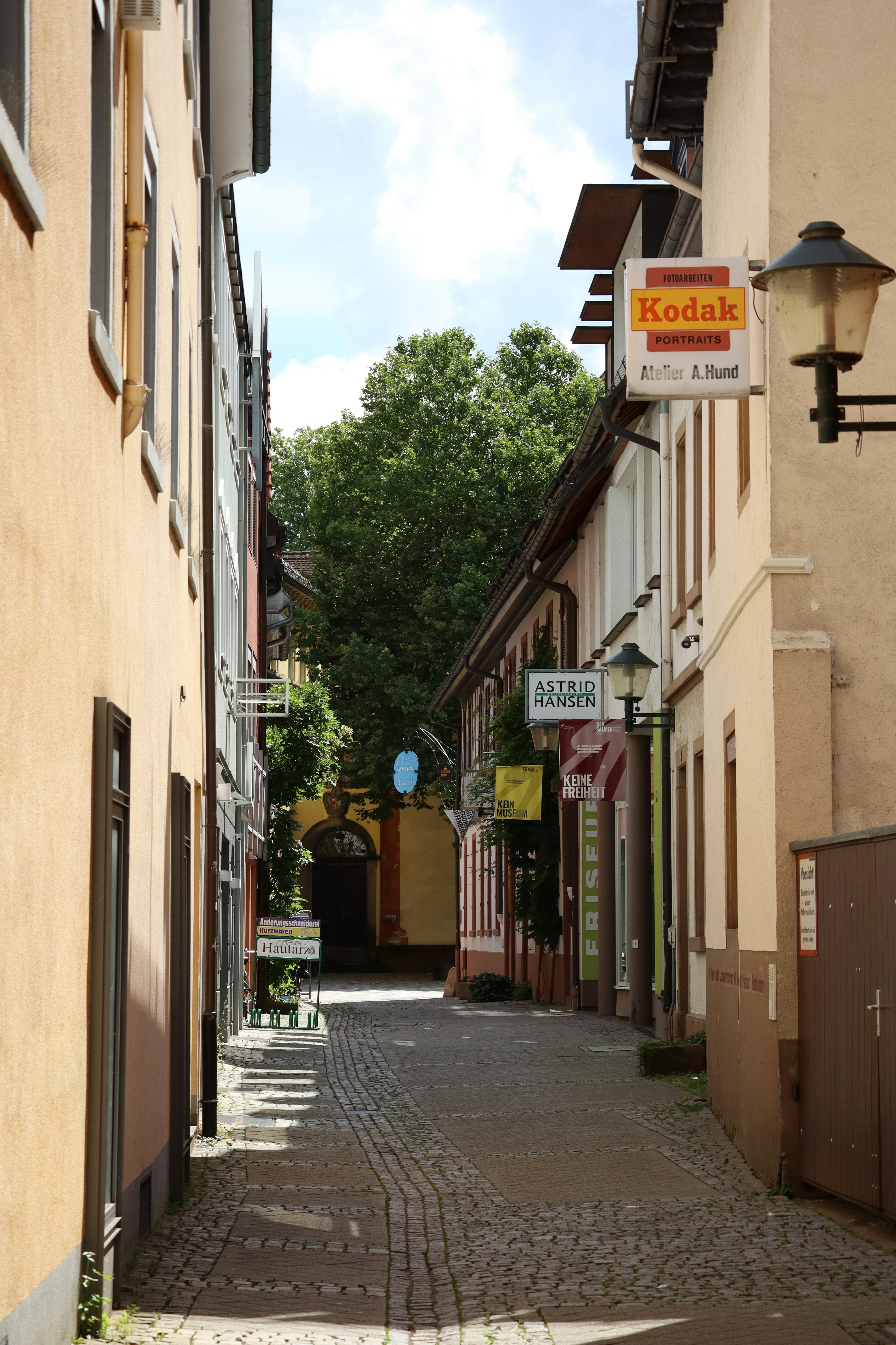 Narrow European Alley Leads to a Sunlit Archway