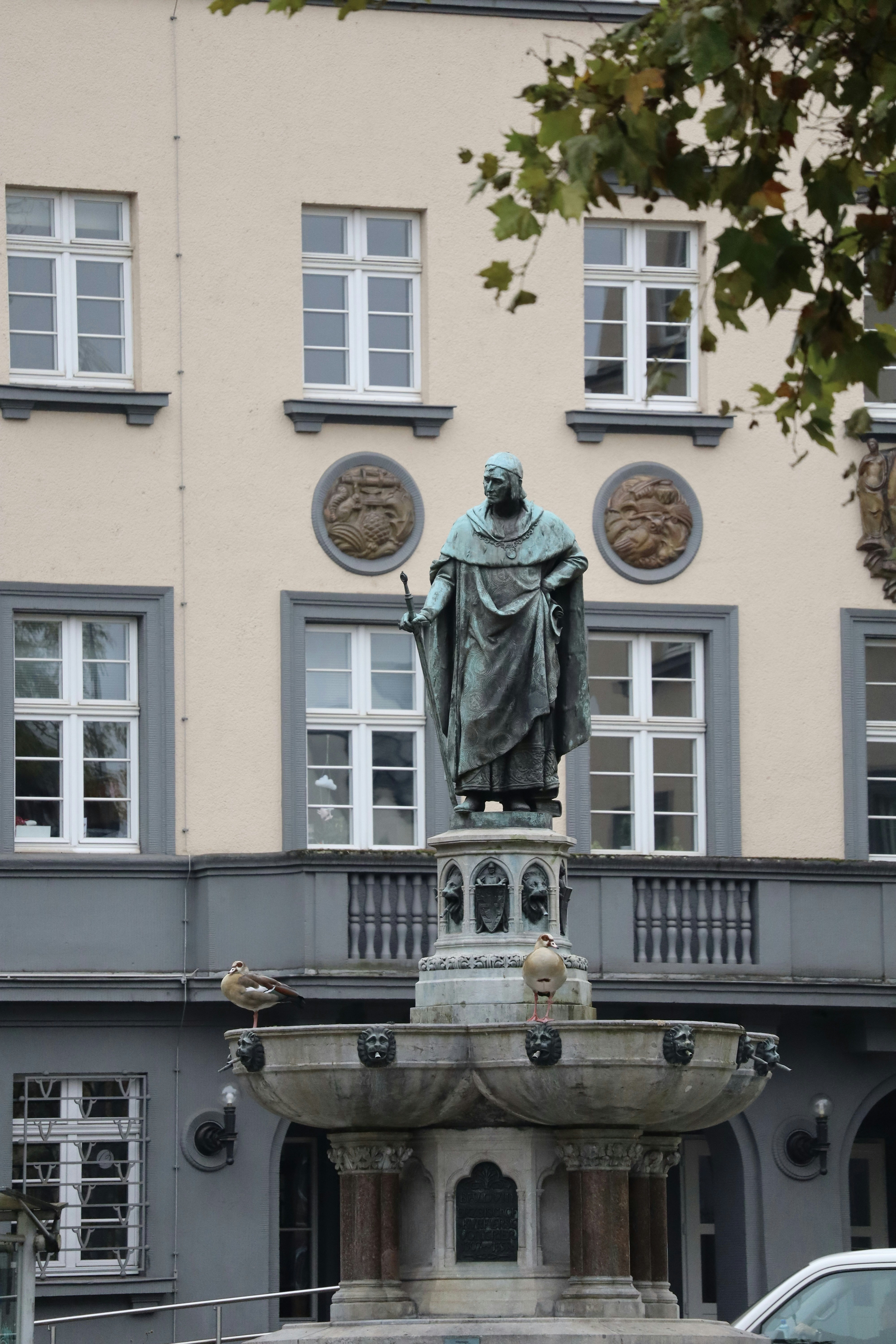 Bronze Statue Overlooking the Square Fountain