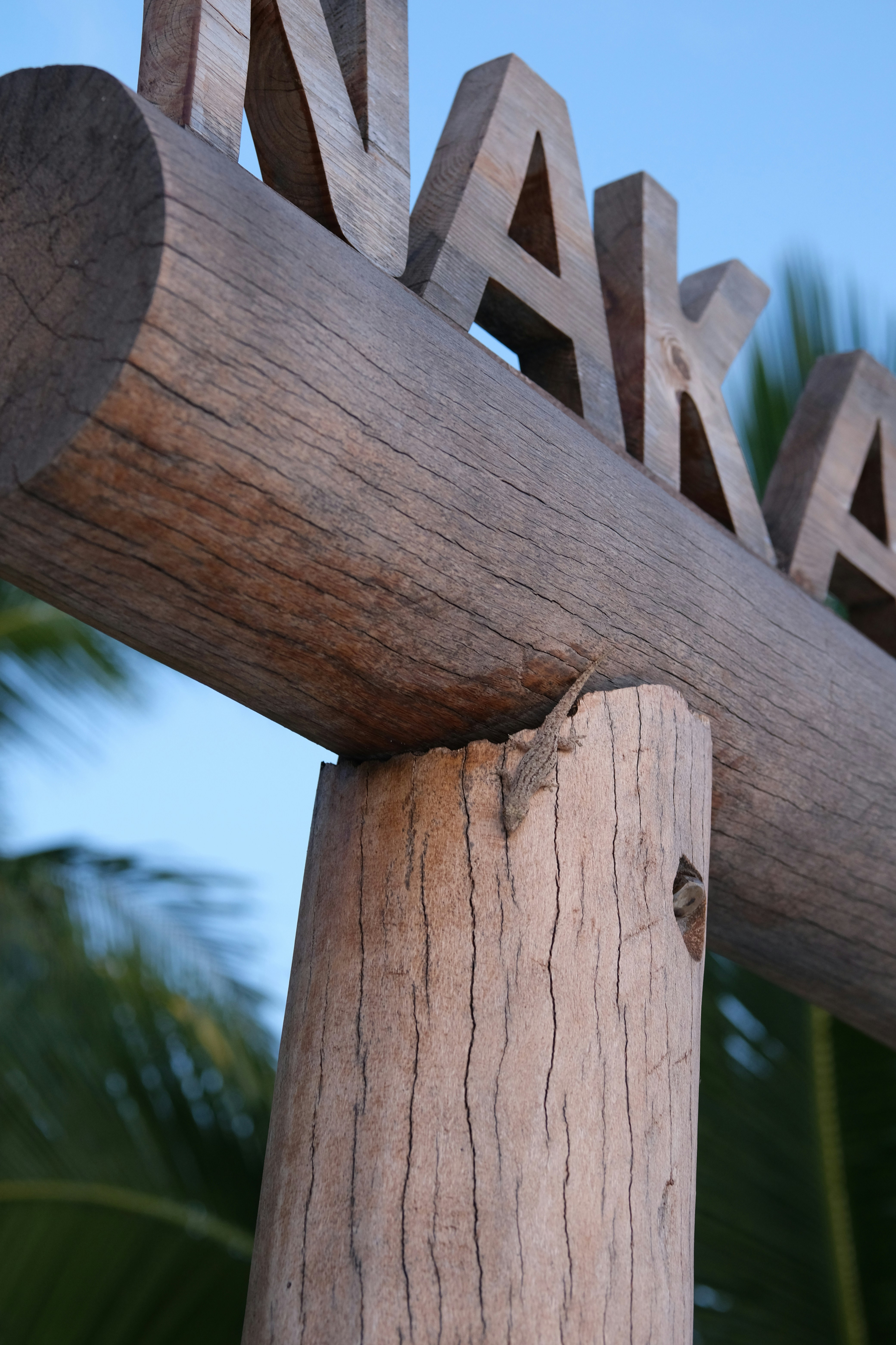 Carved wooden monument under bright blue sky