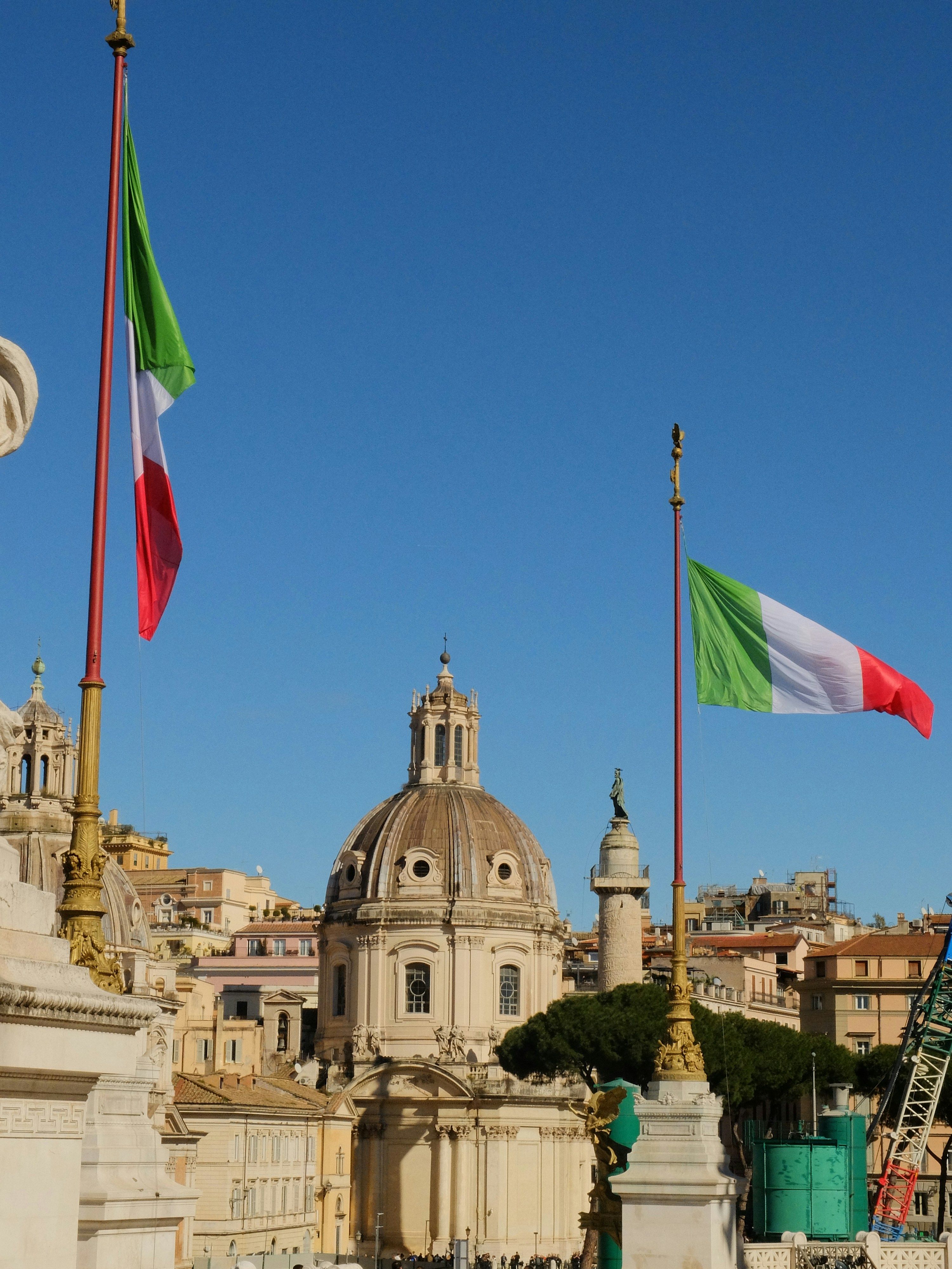 Flagpoles Over Rome: A Panoramic View of the Dome and Flags