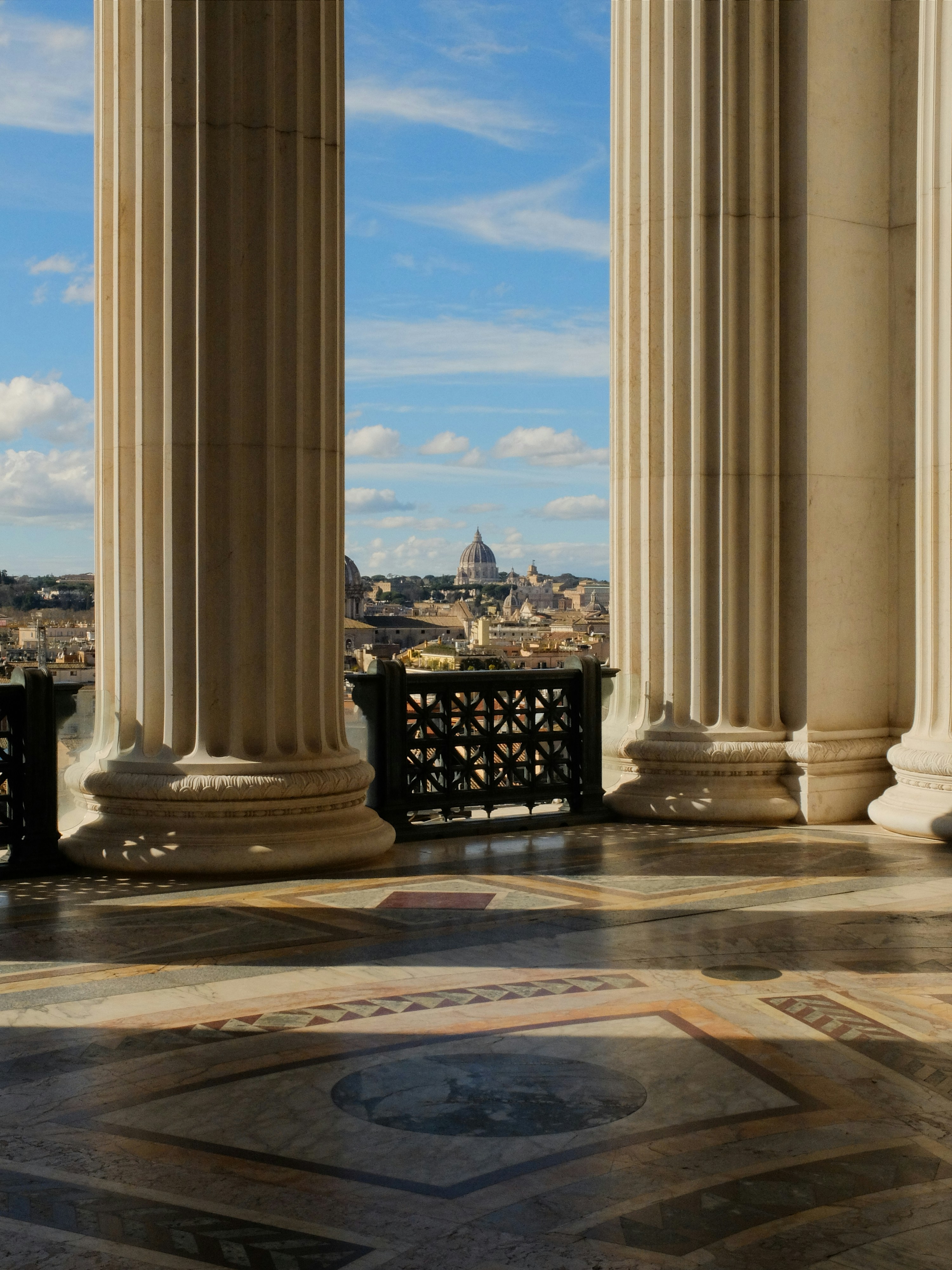 Colonnade Vista: City Dome Framed by Monumental Columns