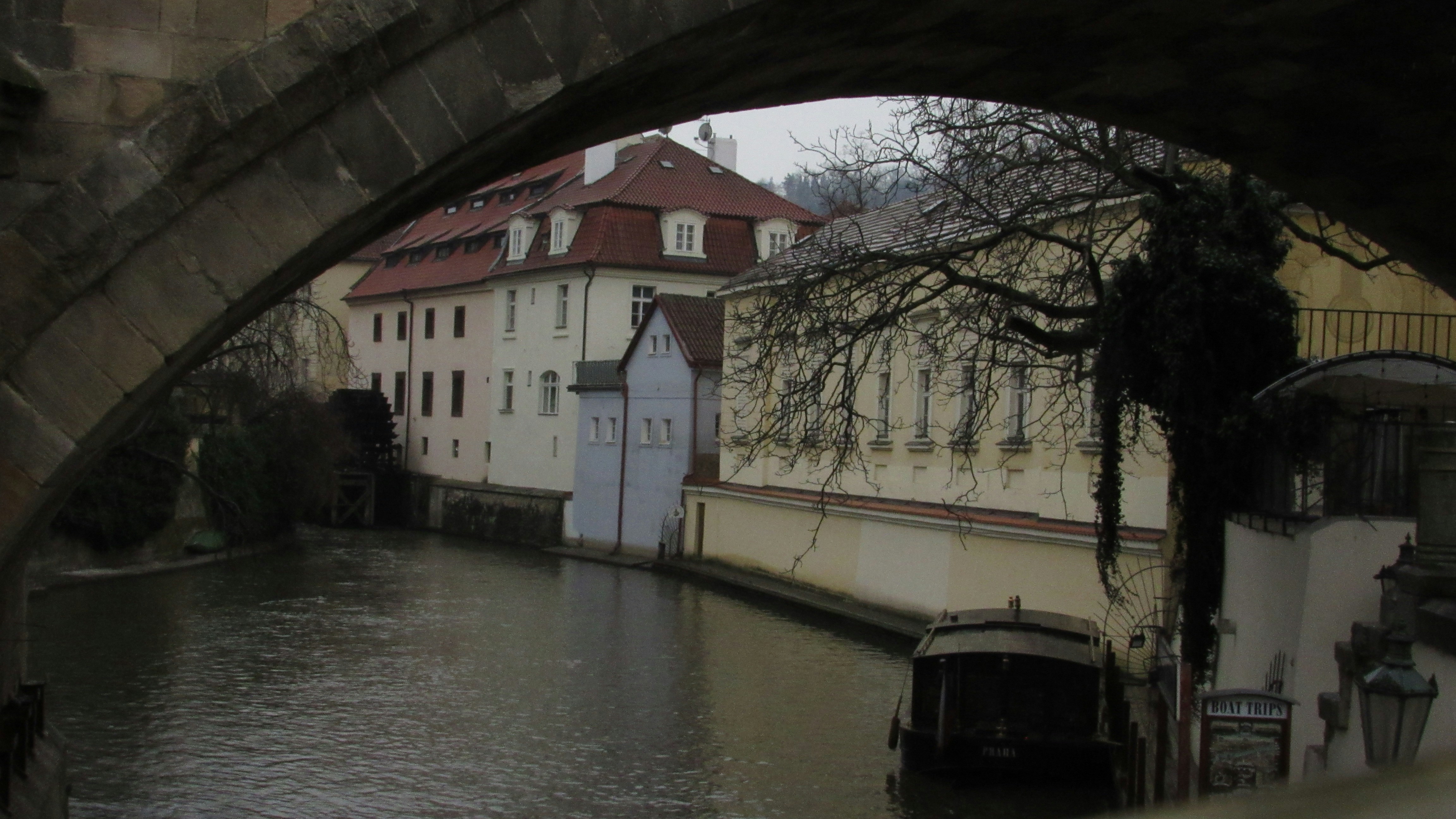 Arched Bridge Over Quiet Canal: A Quiet European Courtyard