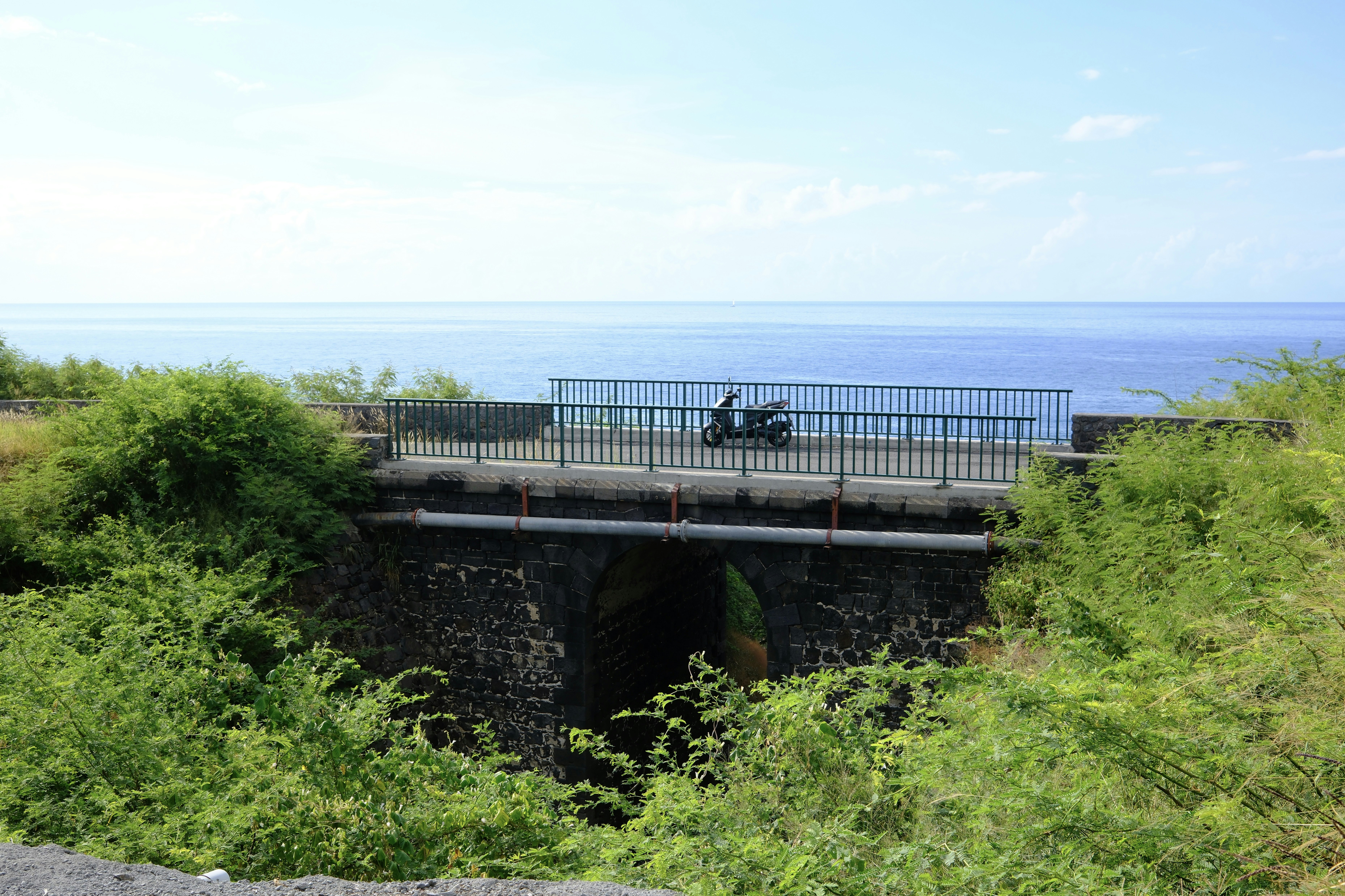 Bridge overgreen Atlantic: scooter resting on a seaside rail