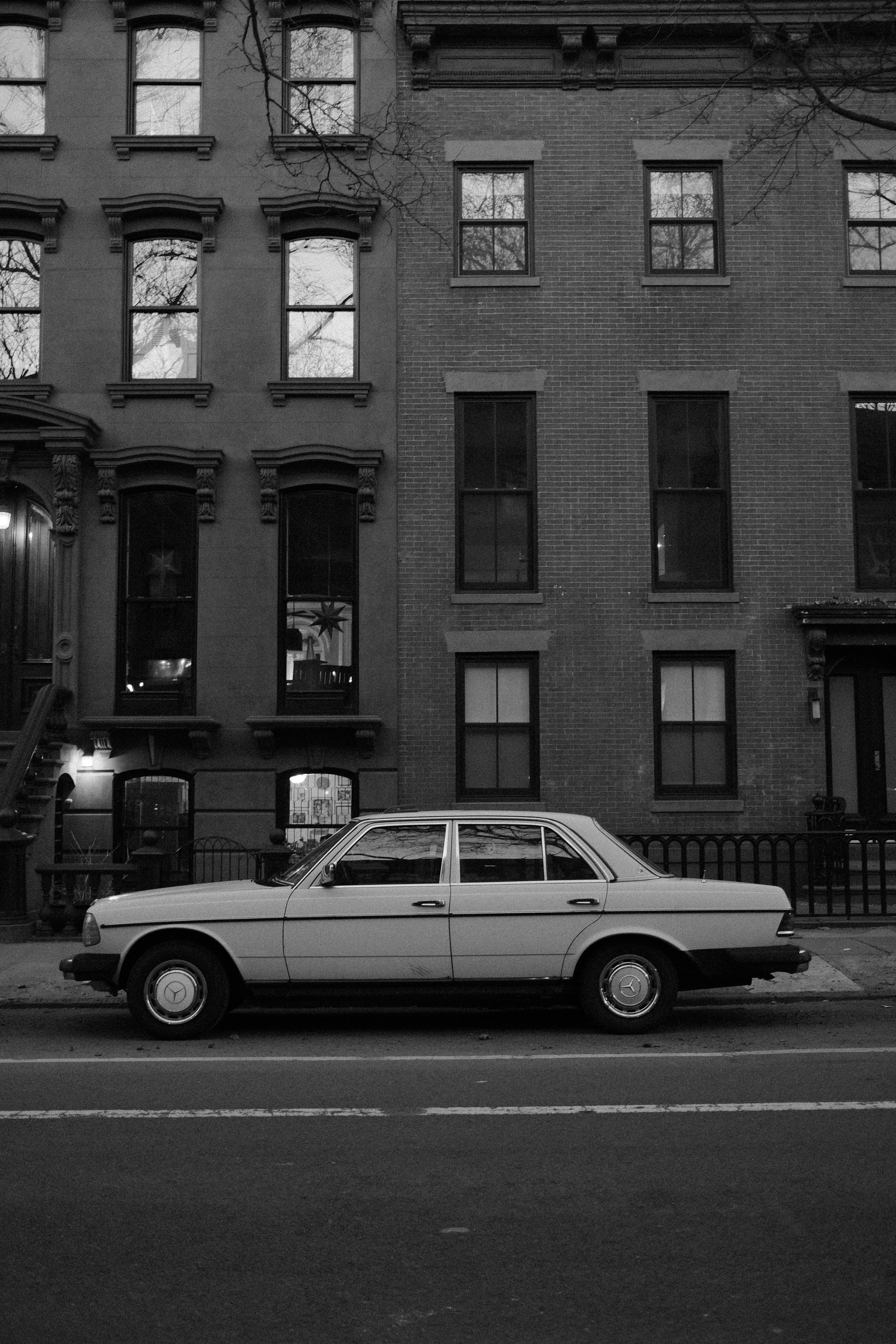 Midnight Inline: A Classic Sedan Anchored by Urban Brick