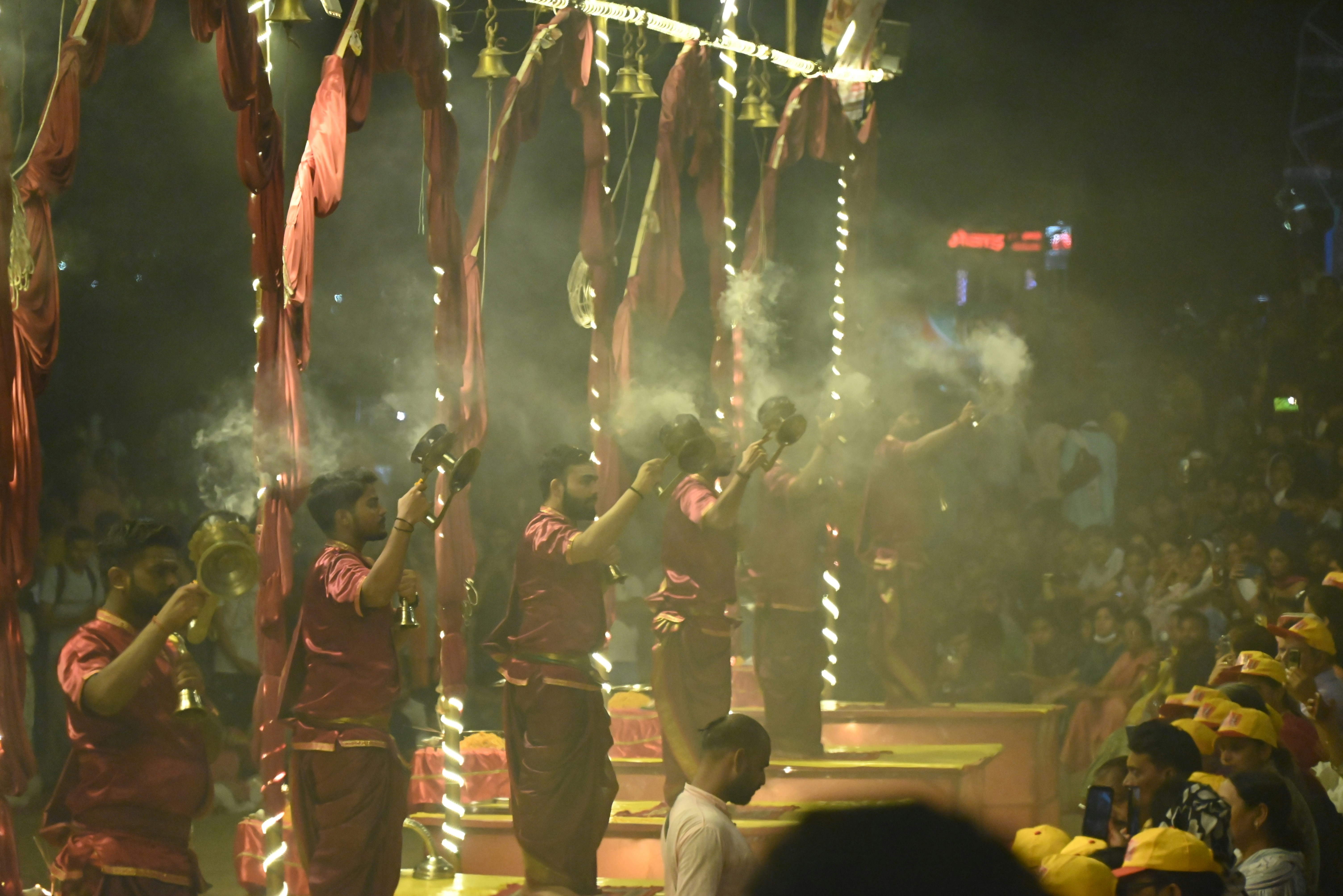 Stage Ritual: Dancers in Red Amid Smoke and Spotlight