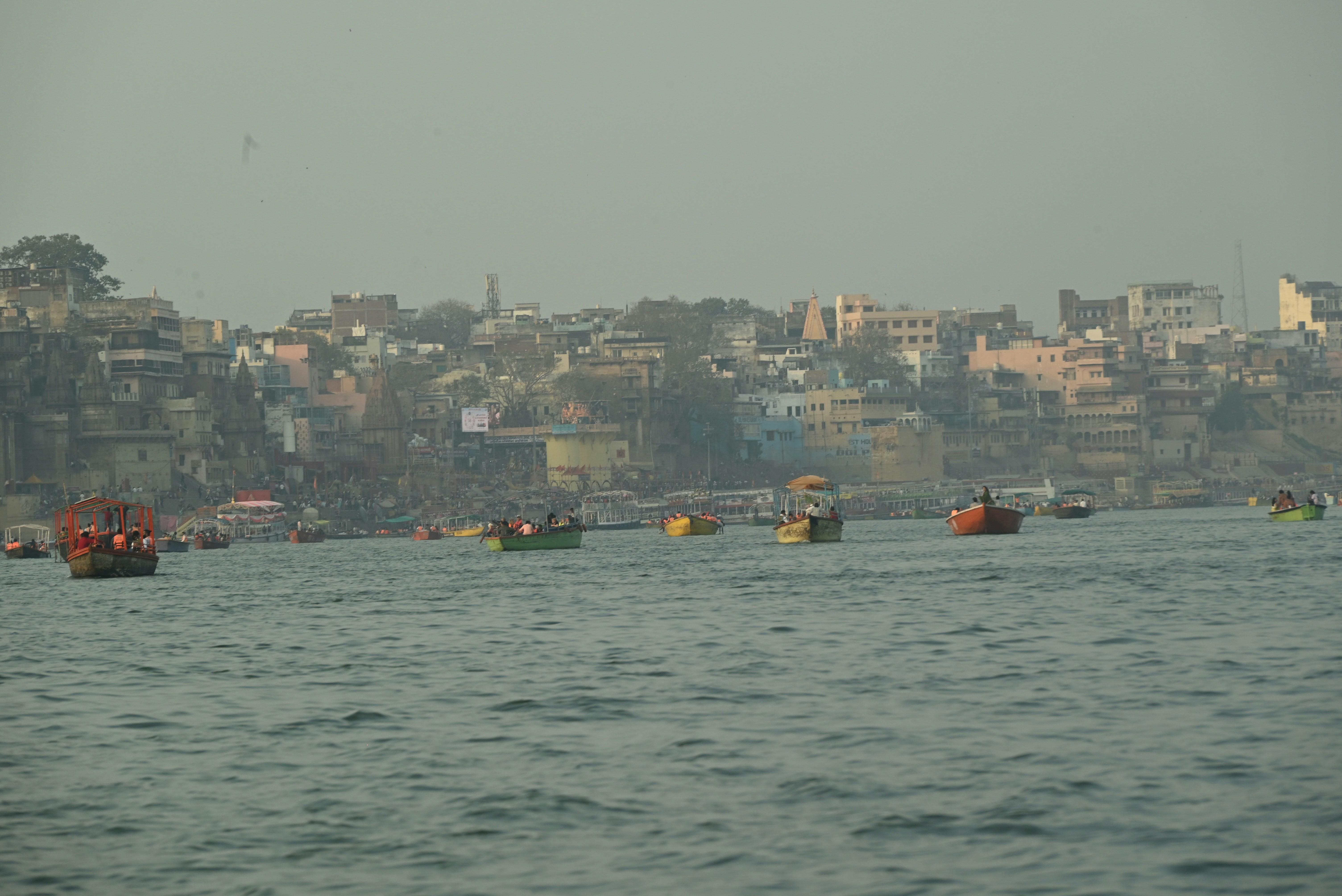 Harbor Wake: Boats Dot a Distant Waterfront City