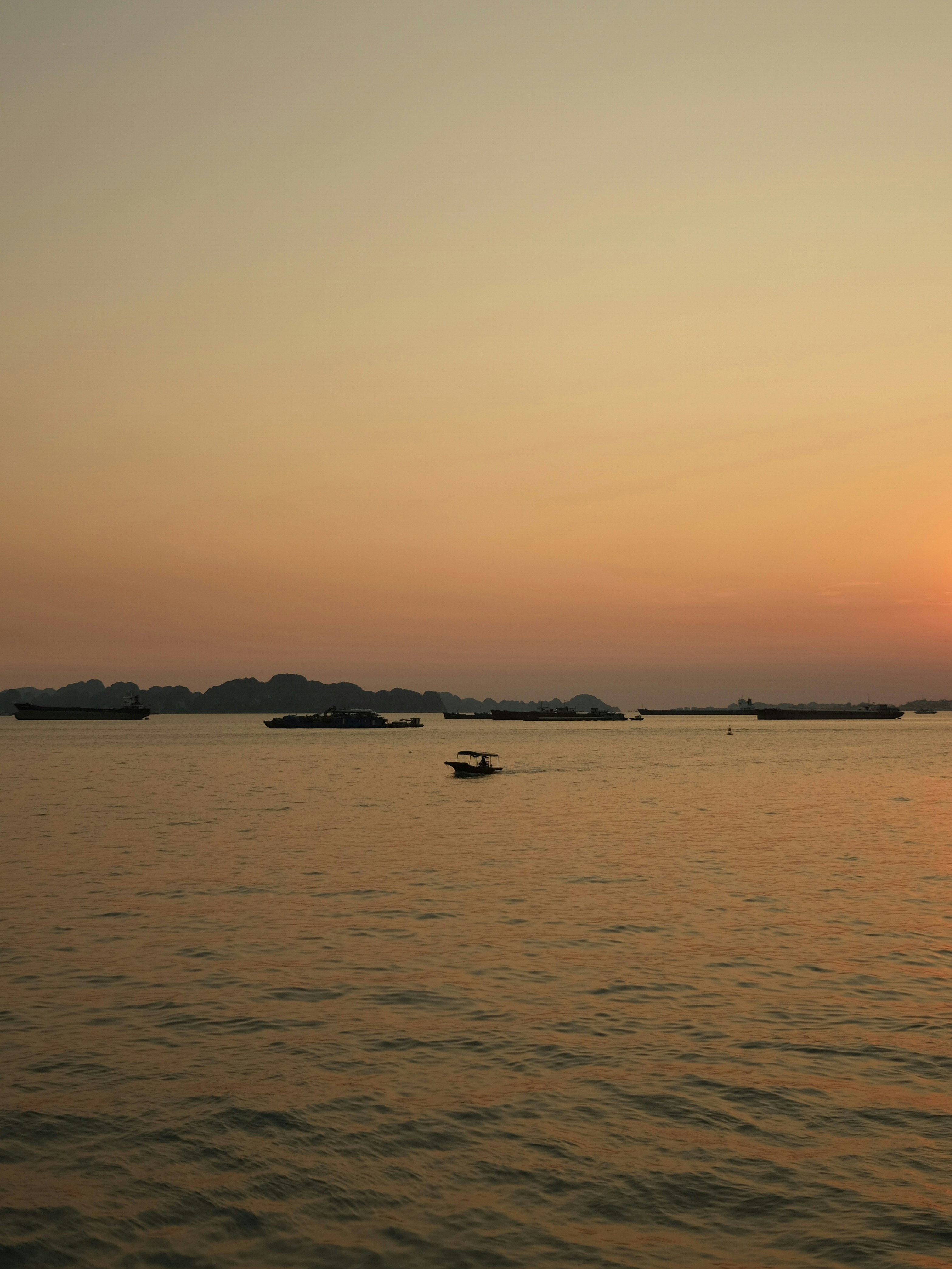 Silhouetted Boats on a Velvet Sea at Sunset