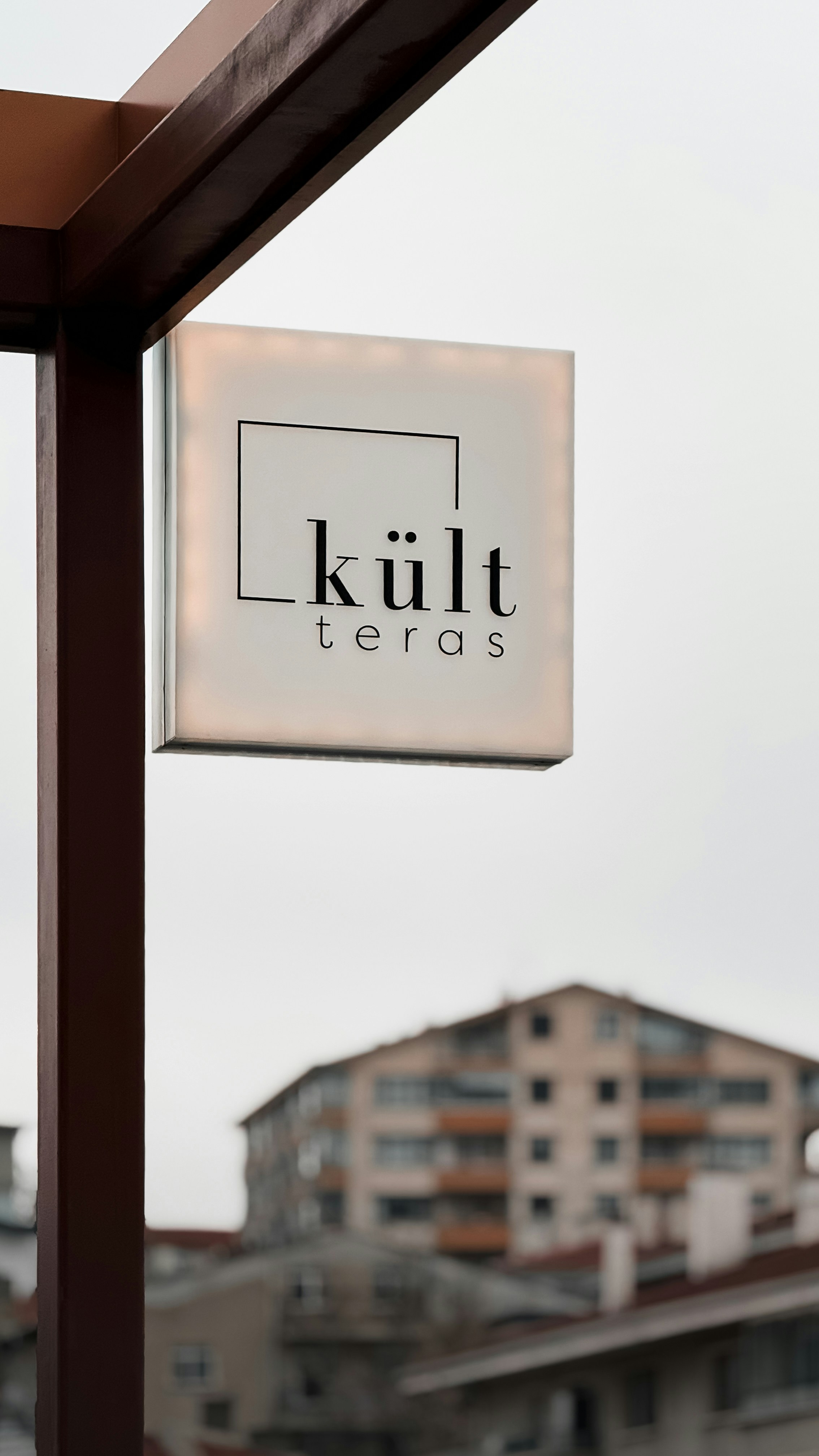 Minimal storefront sign in a soft urban setting