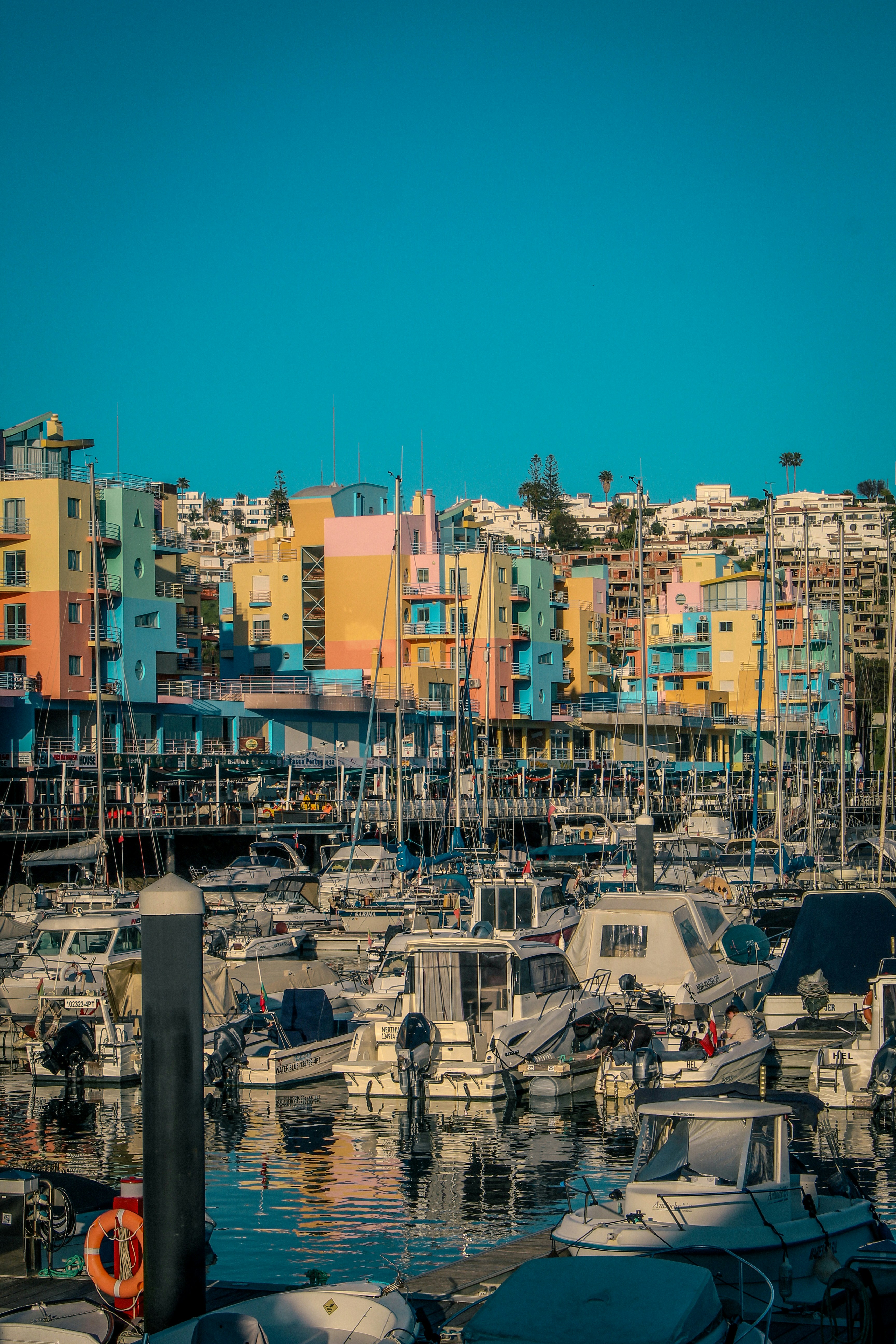 Colorful riverside haven: a marina bounded by candy-colored apartments