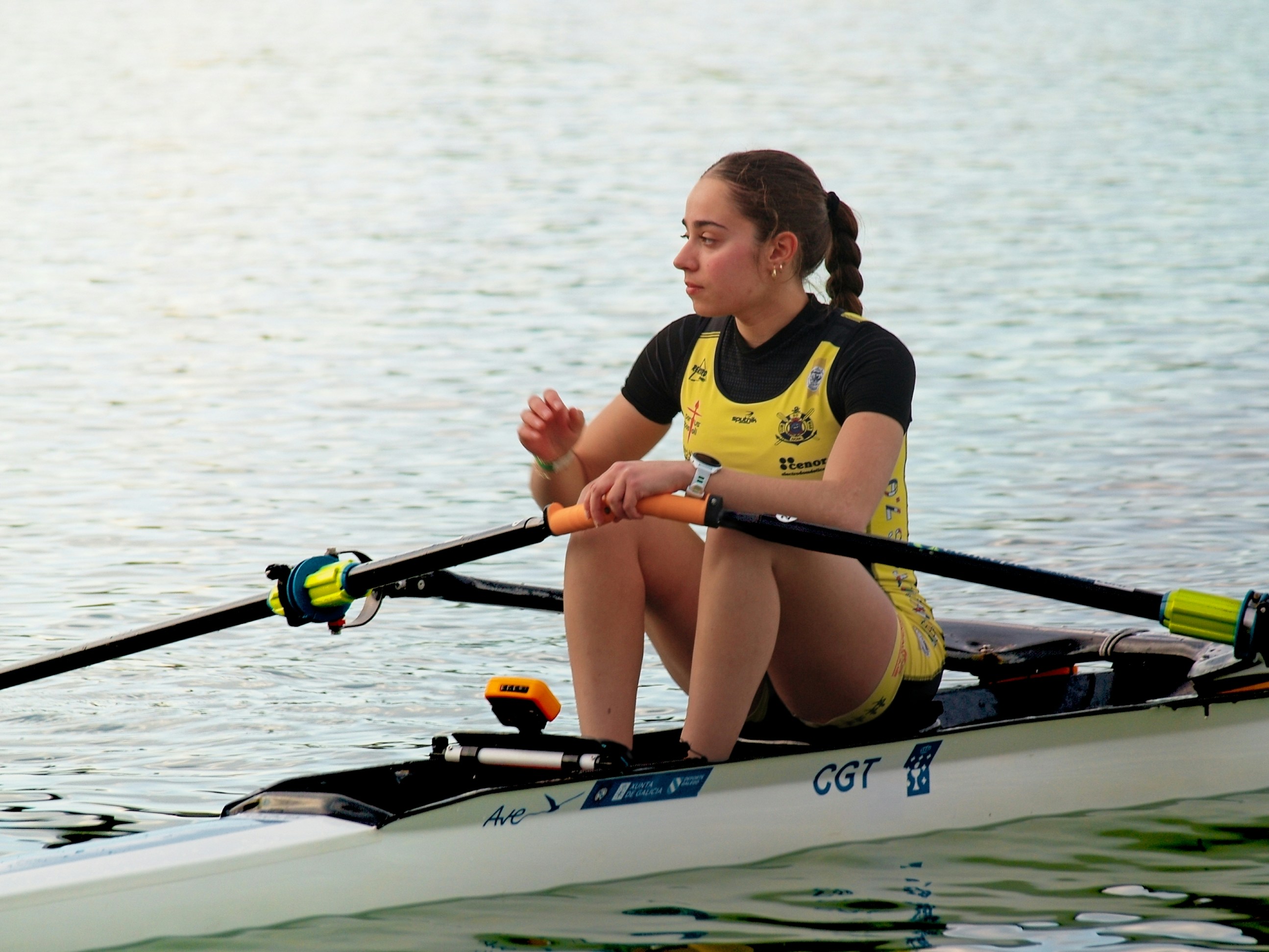 Rower in a Yellow Vest at Rest on a Calm Water Stage