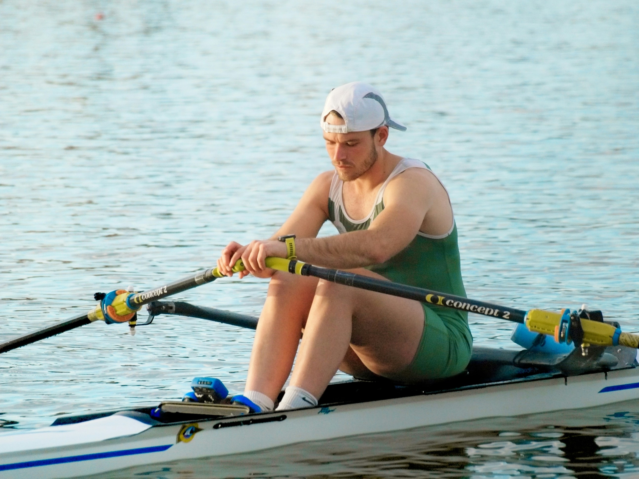 Rower in a Quiet Morning: Focused Poise on a Narrow Wake