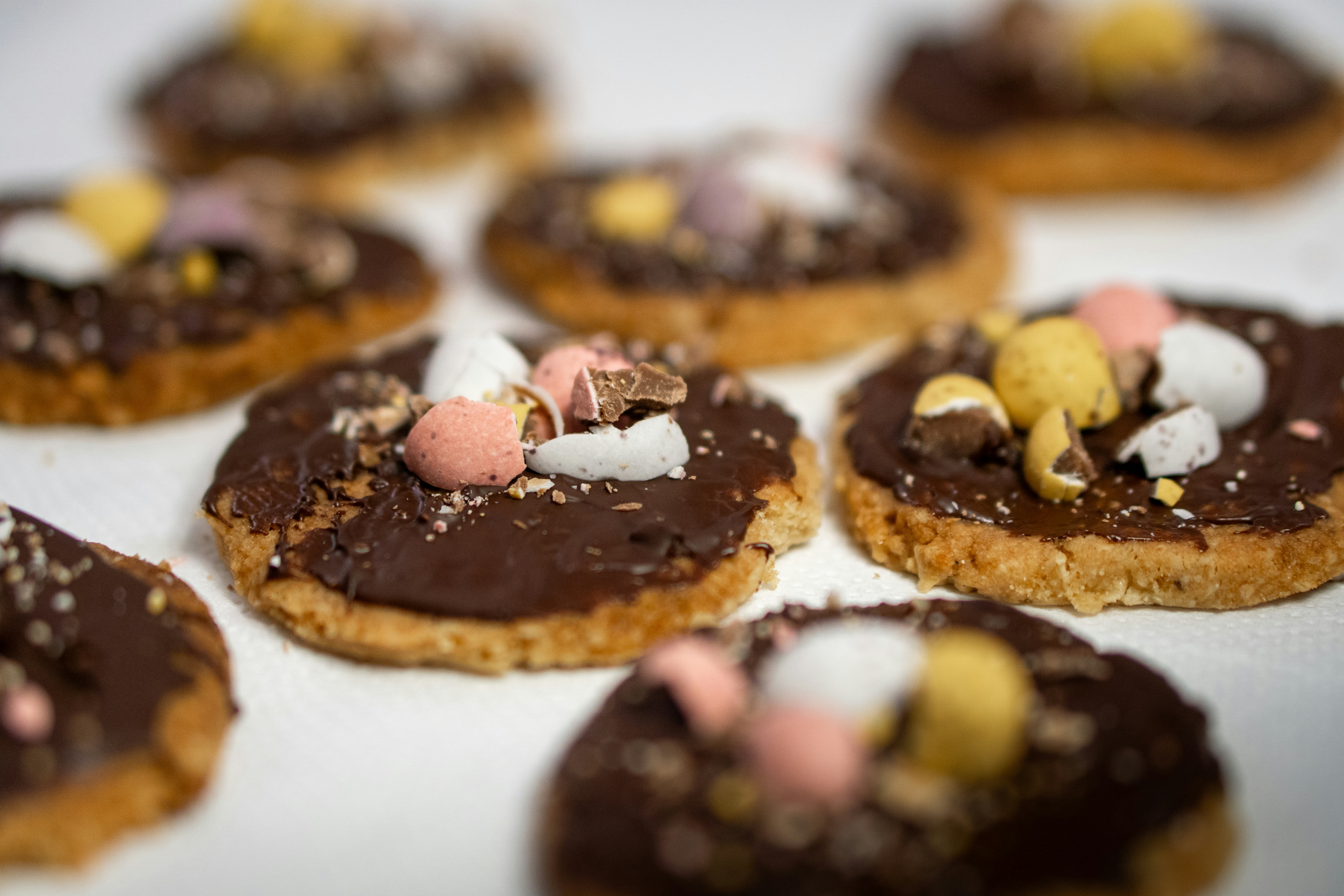 Chocolate cookies topped with colorful candy eggs