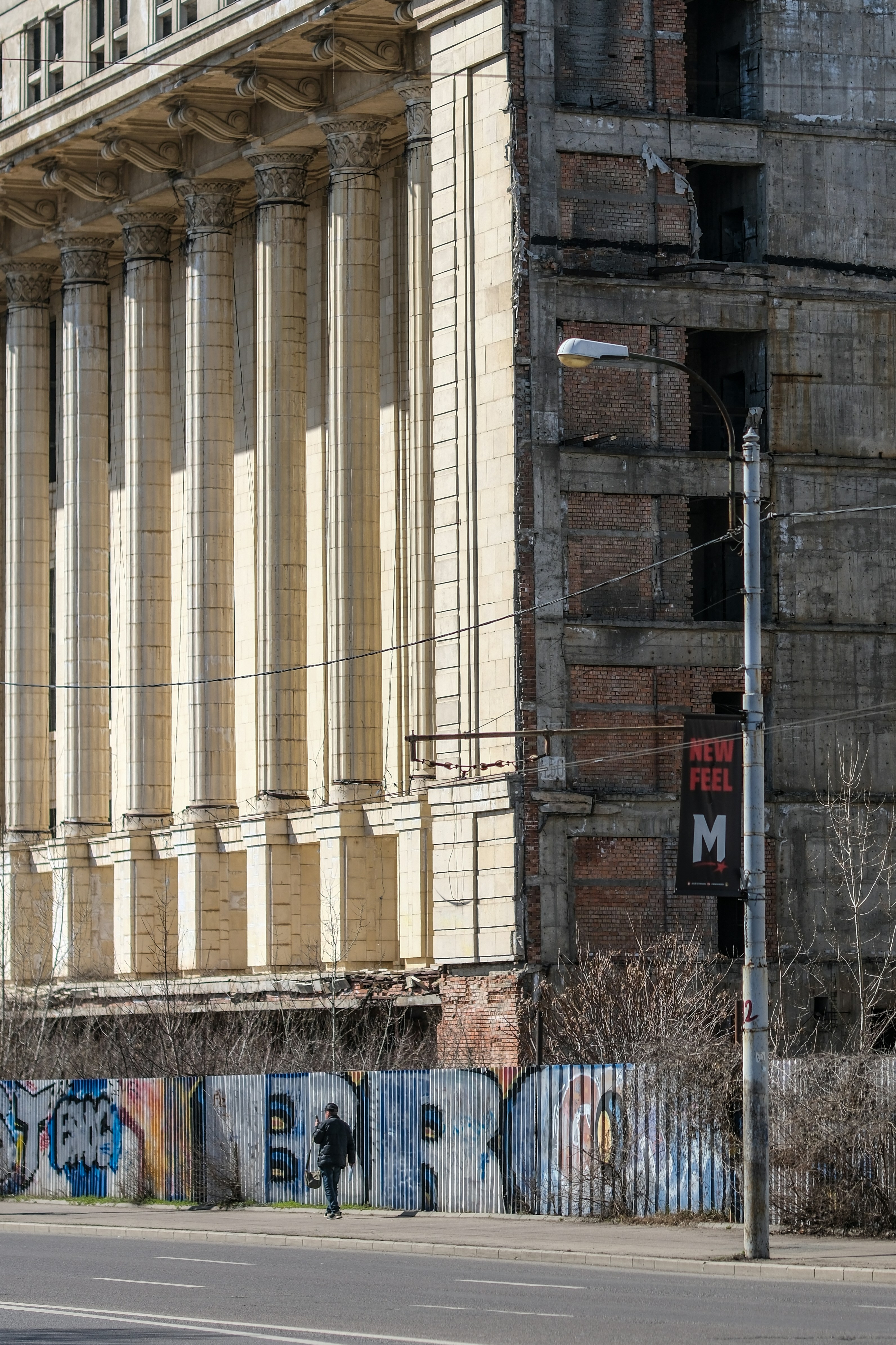 Sunlit Colonnade Against a Facade of Ruin