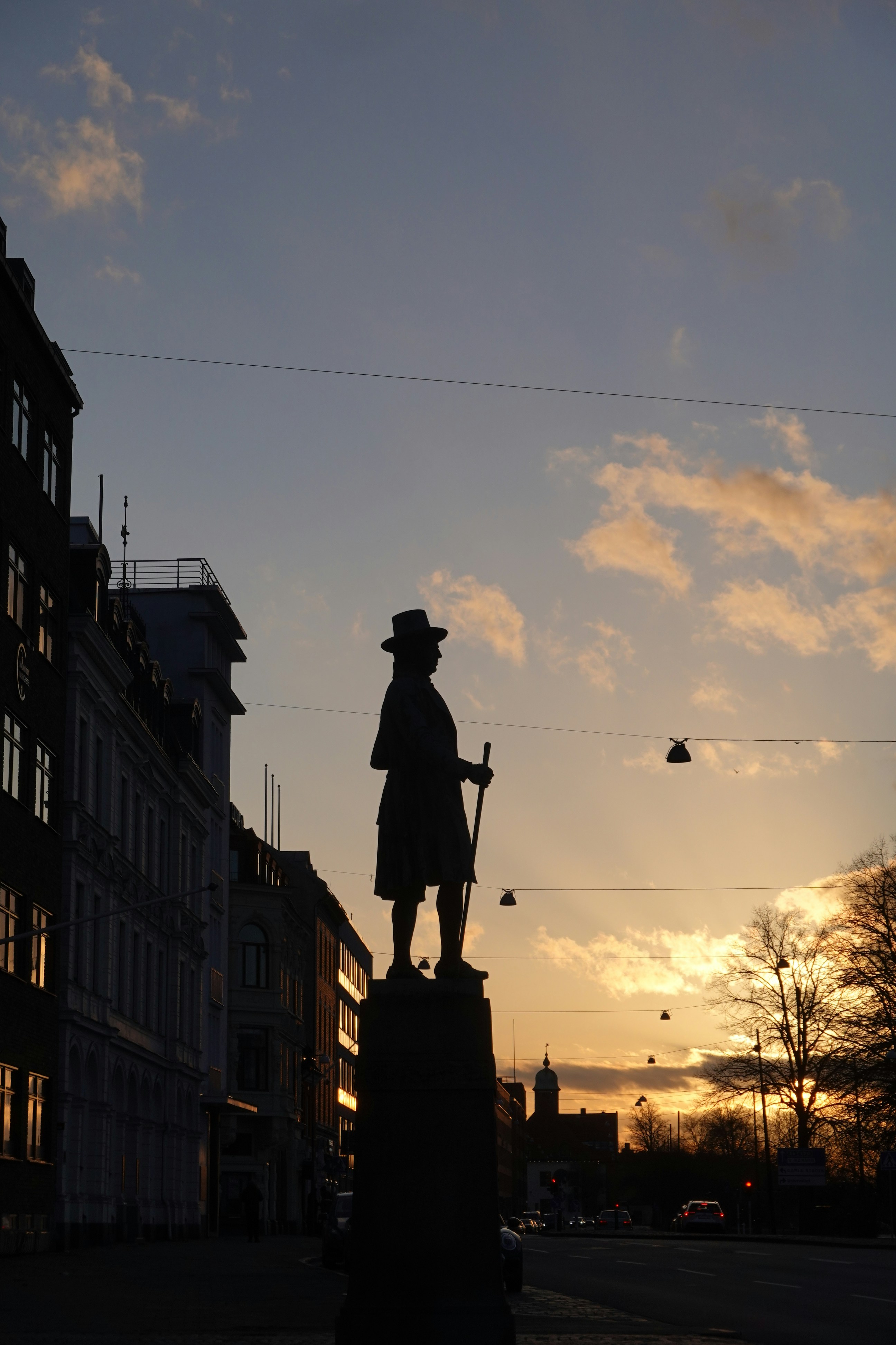 Silhouette of a Watchful Figure in the Sunset City