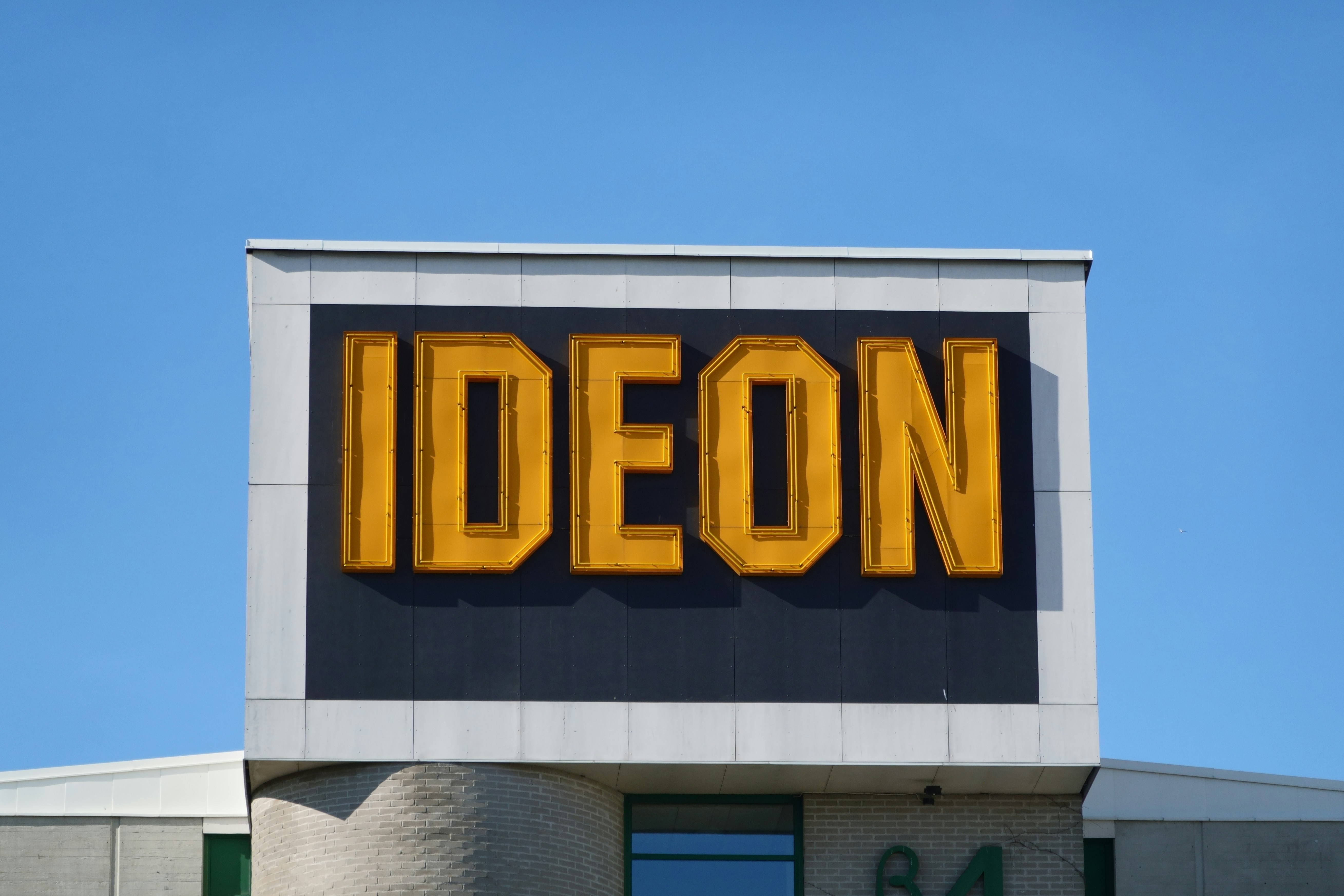 Golden Letters on a Clear Blue Sky at the IDEON Sign